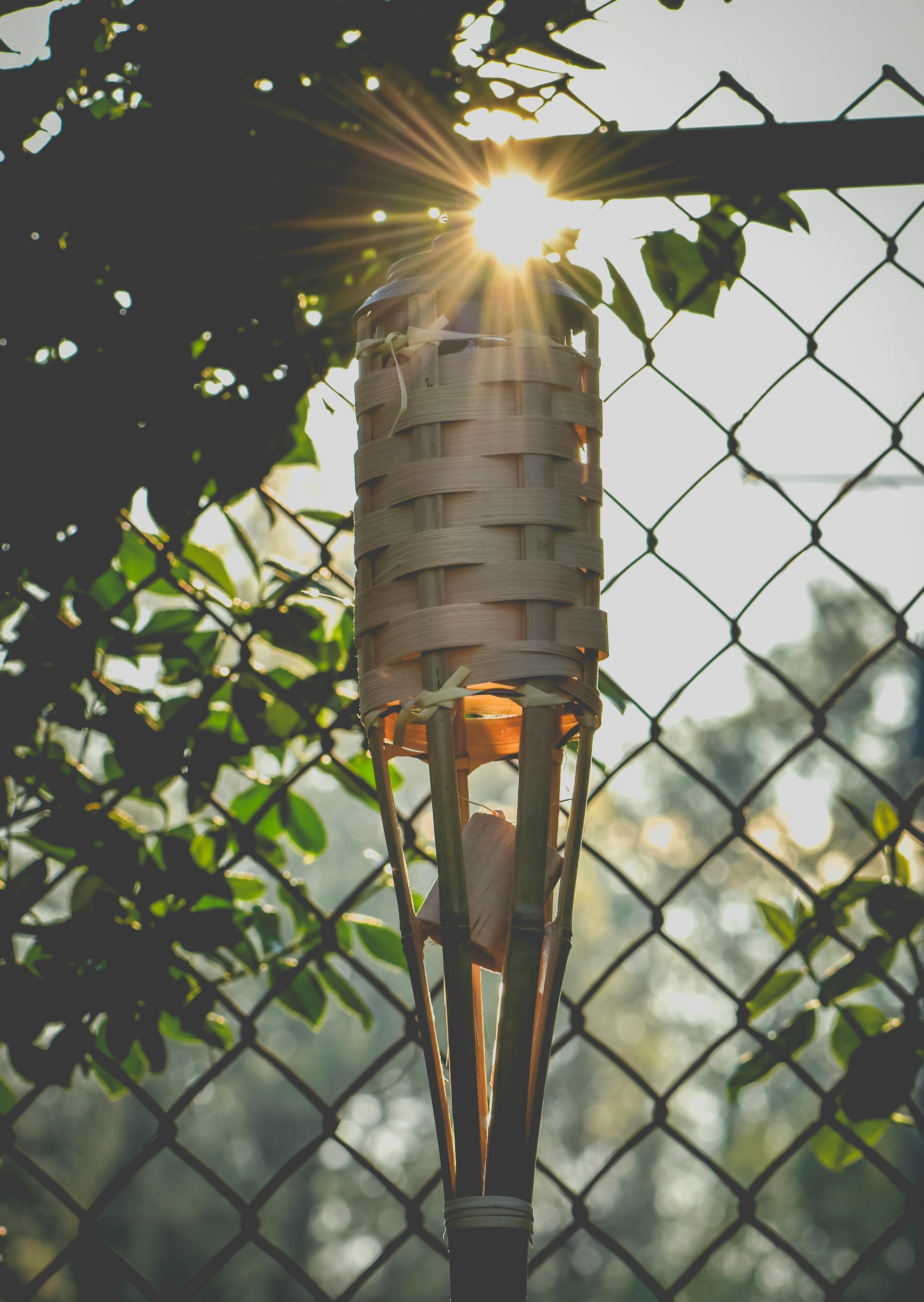 Wooden Torch Near the Metal Fence · Free Stock Photo