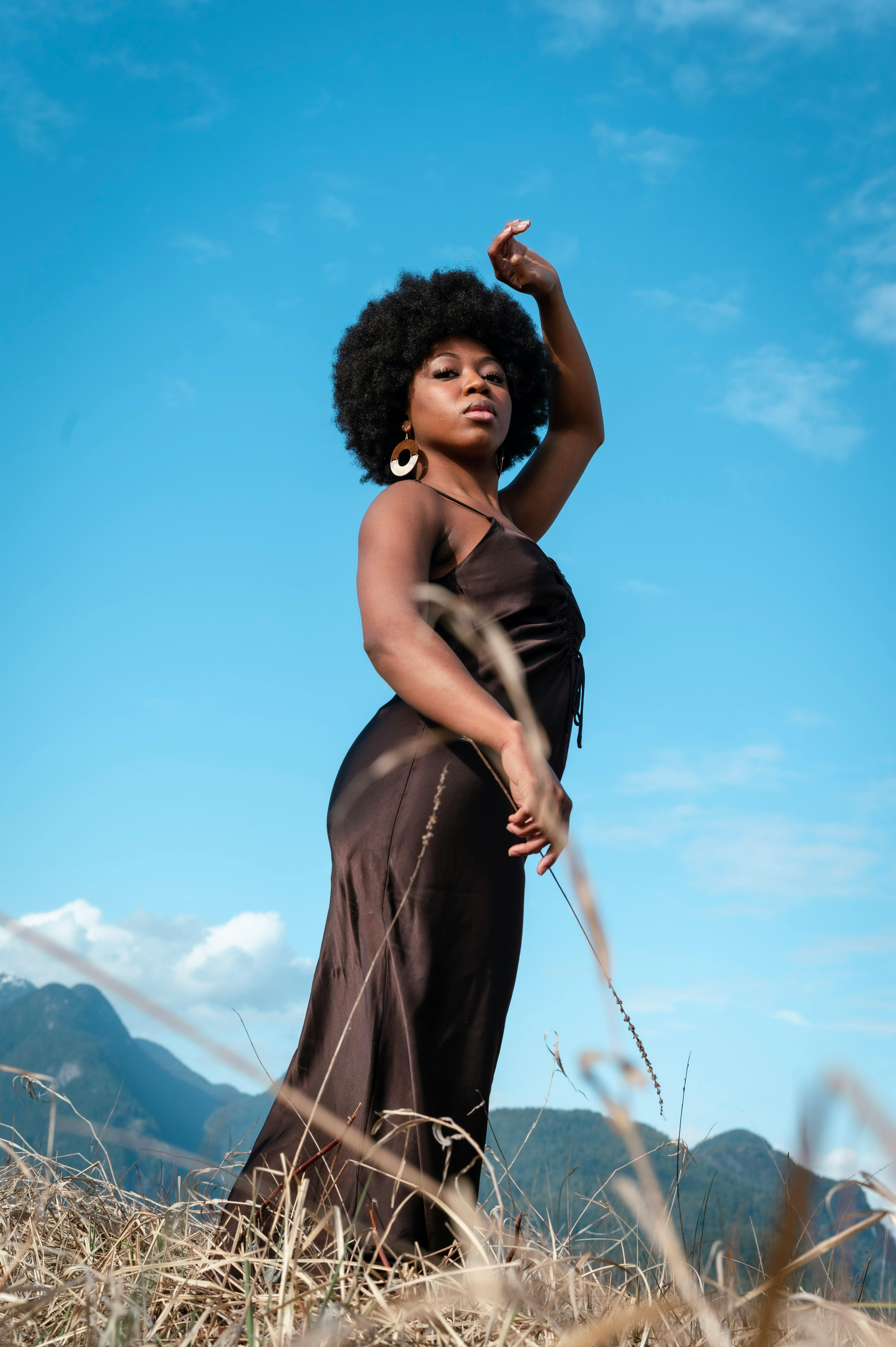 Woman in Orange Robe Standing on White Floor · Free Stock Photo
