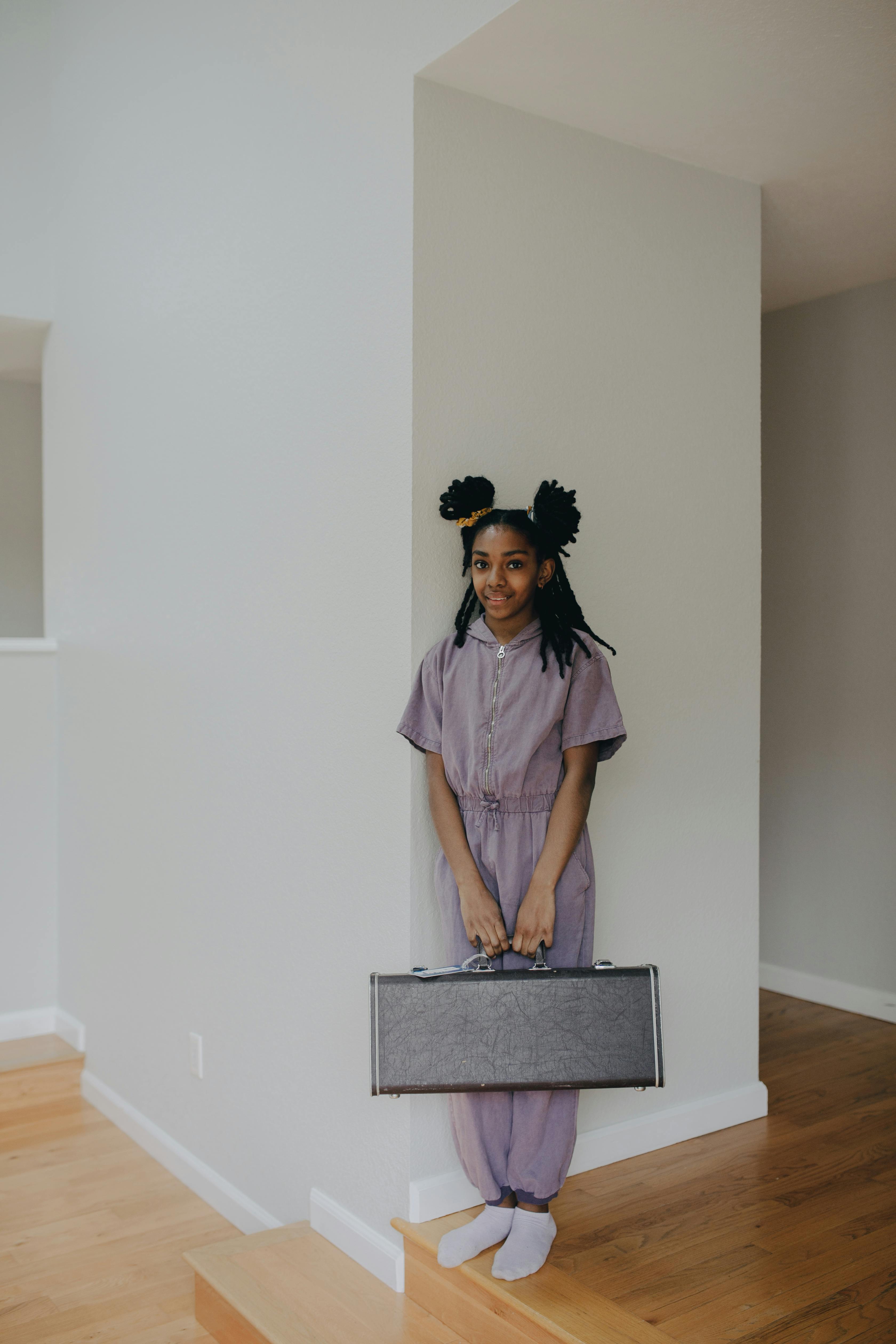 Woman in Gray Jumper Holding Black Luggage · Free Stock Photo