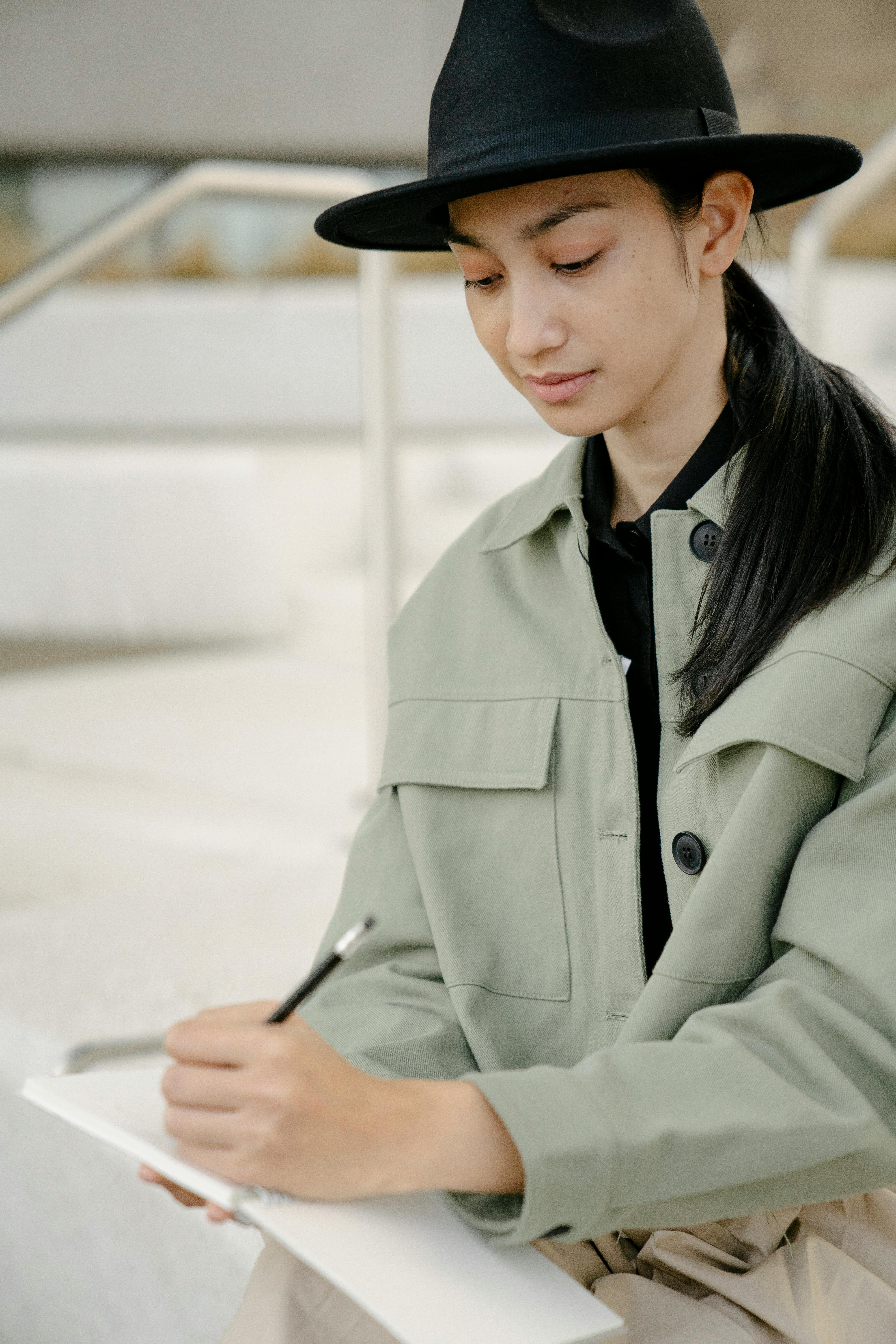 Woman in Gray Jacket Writing on Notebook · Free Stock Photo