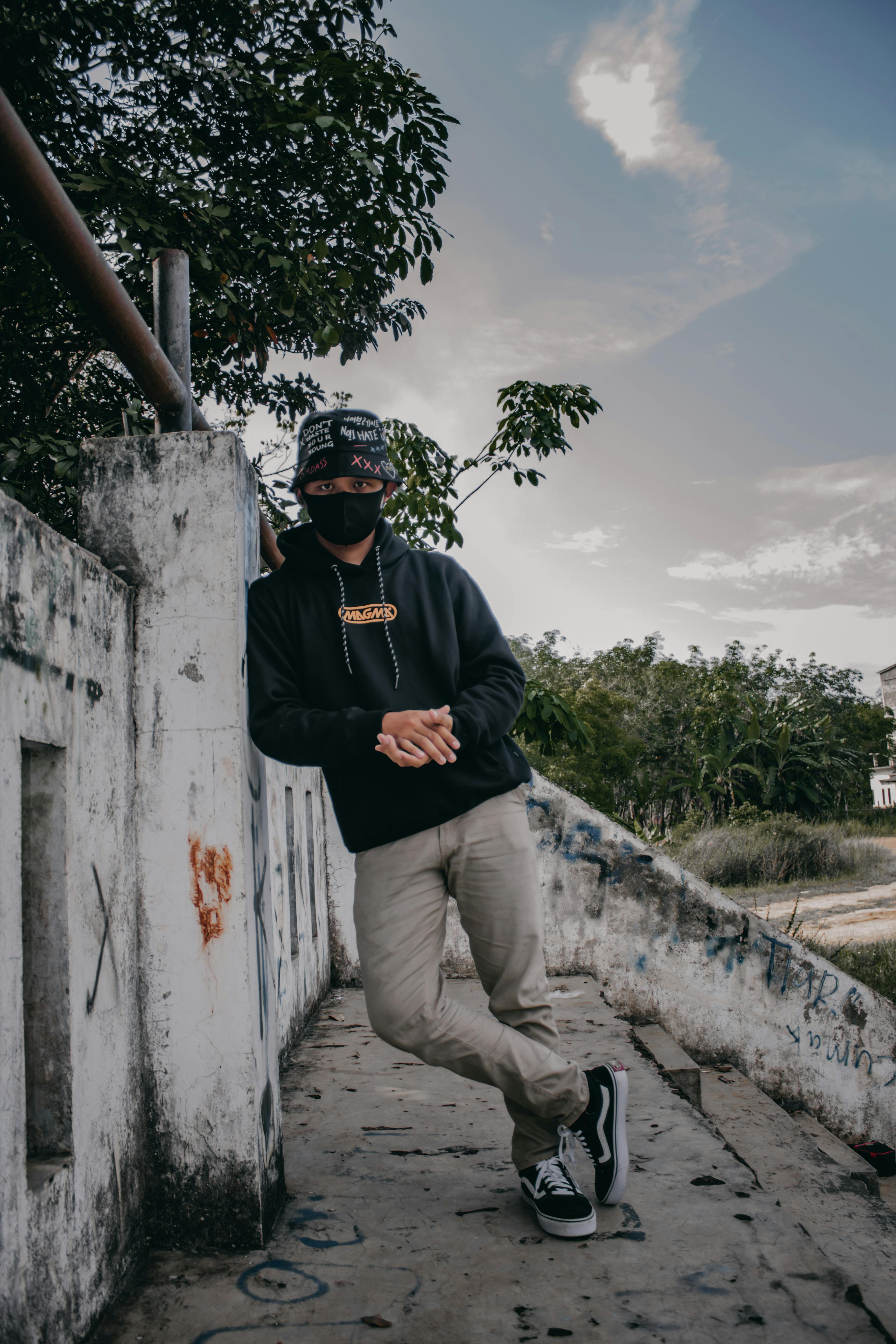 Photo of a Man with a Blue Bucket Hat Covering His Face · Free Stock Photo