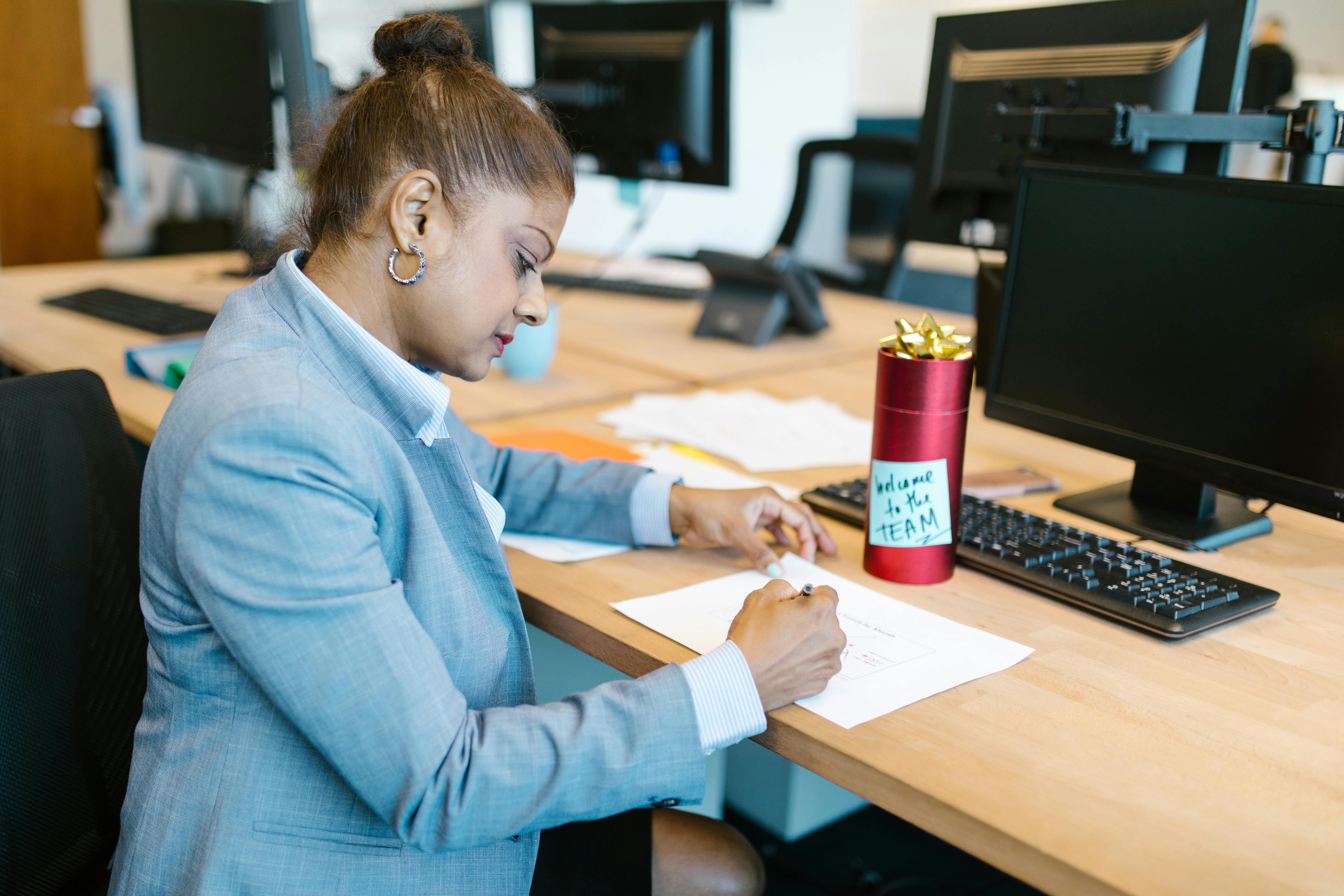 Woman Writing on a Paper · Free Stock Photo