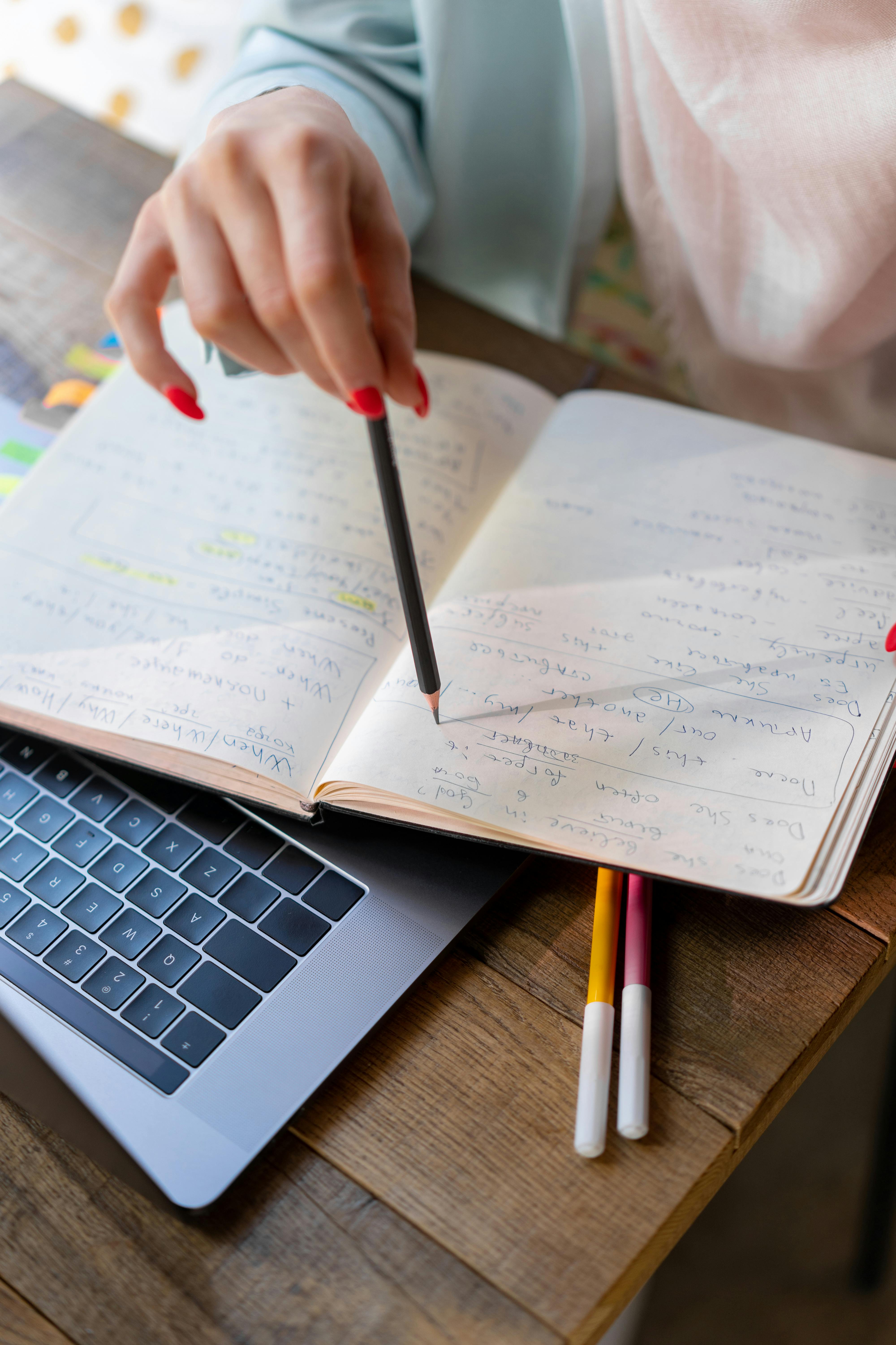 A Person Writing on the Notebook · Free Stock Photo