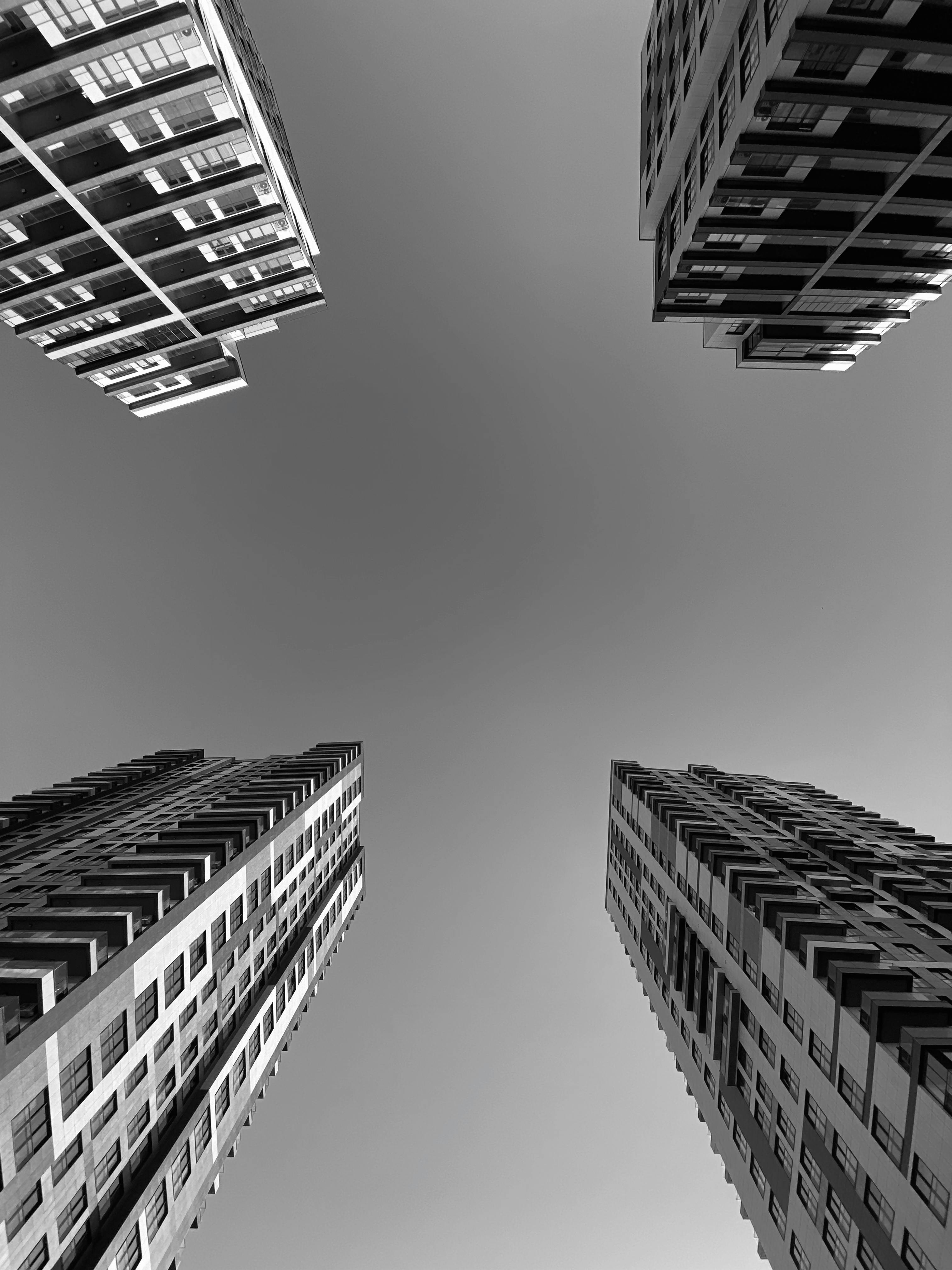 Grayscale Photo of High Rise Buildings Under Clear Sky · Free Stock Photo