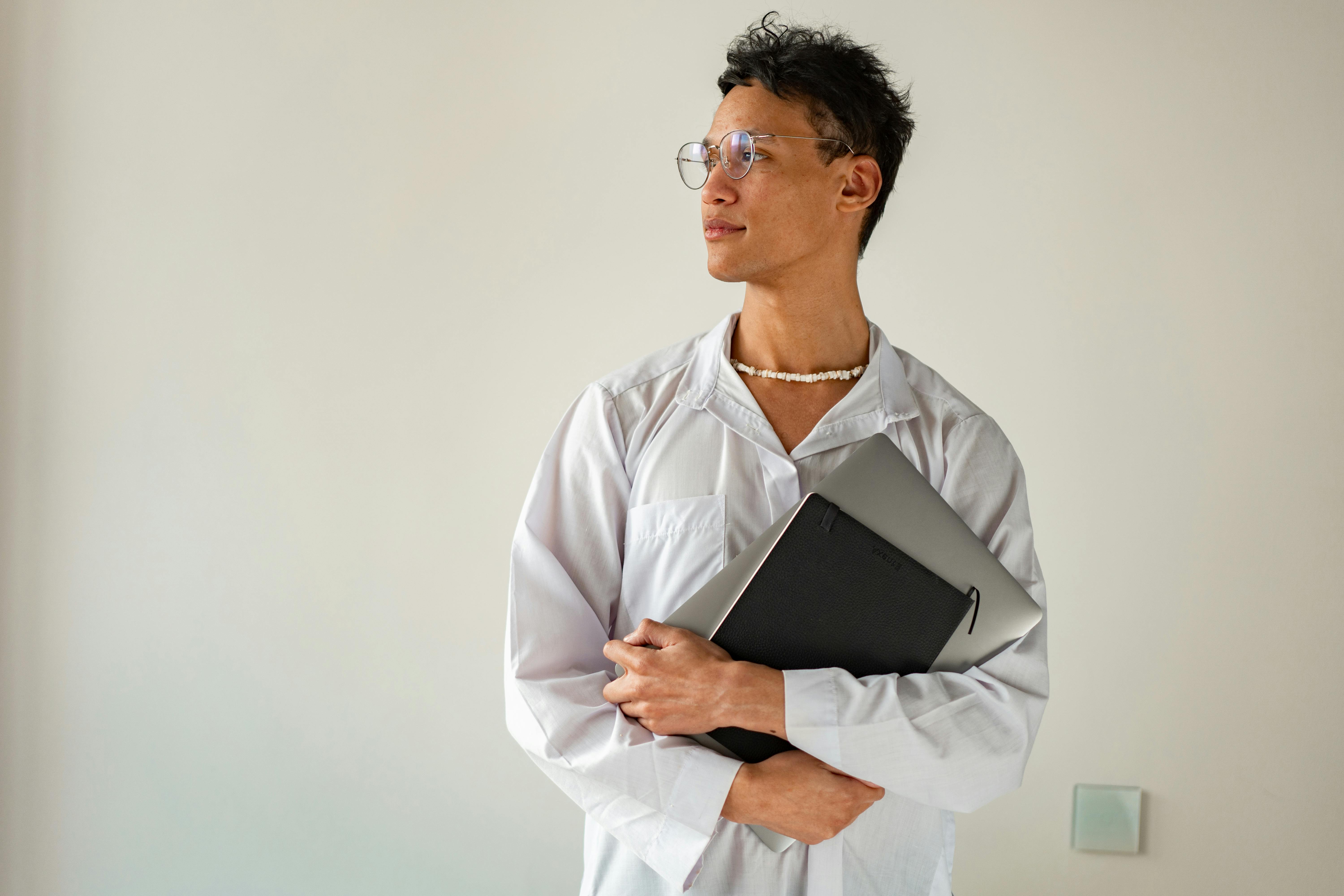 A Man holding Laptop and Notebook · Free Stock Photo