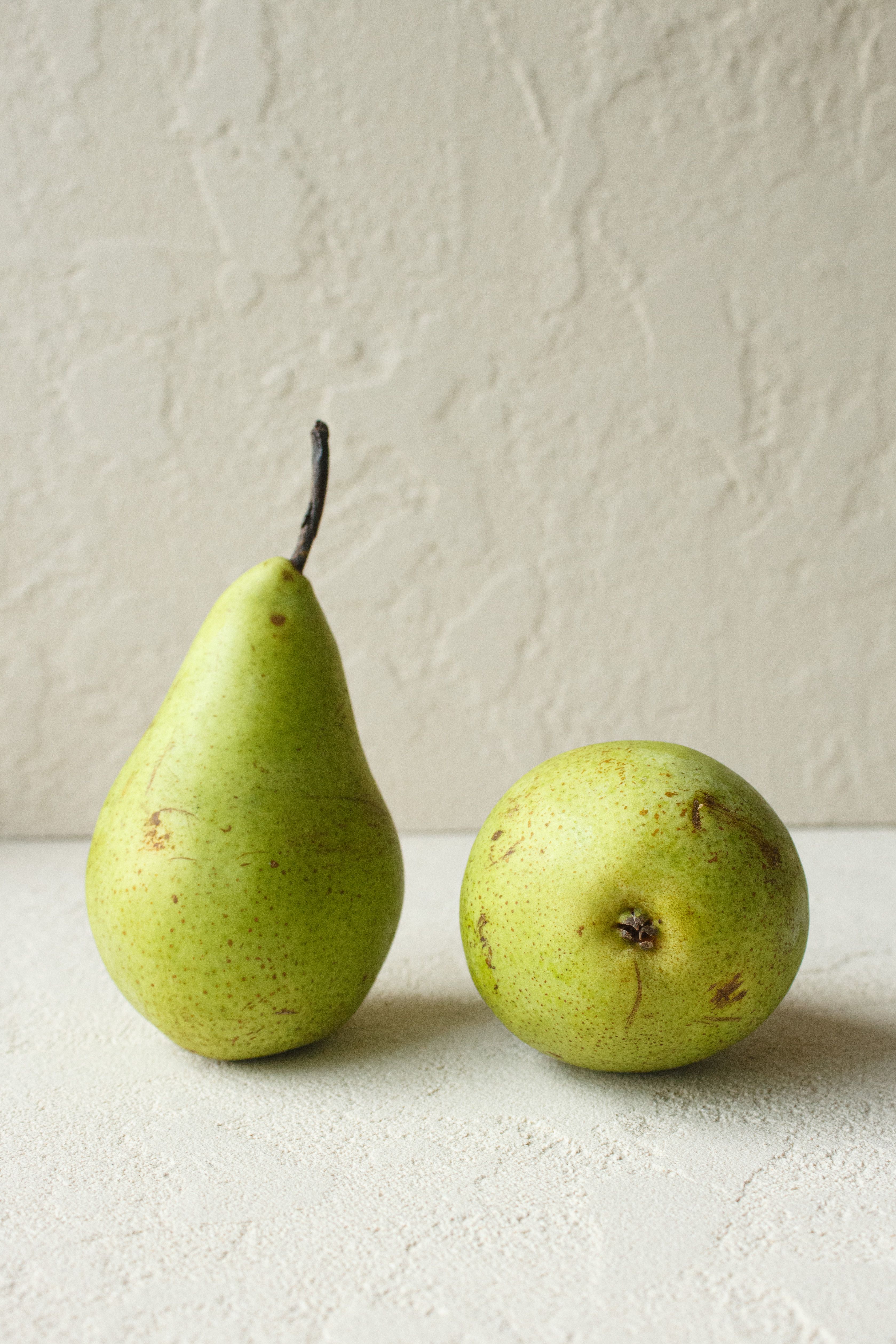 Photo of a Pear Near a Vase · Free Stock Photo