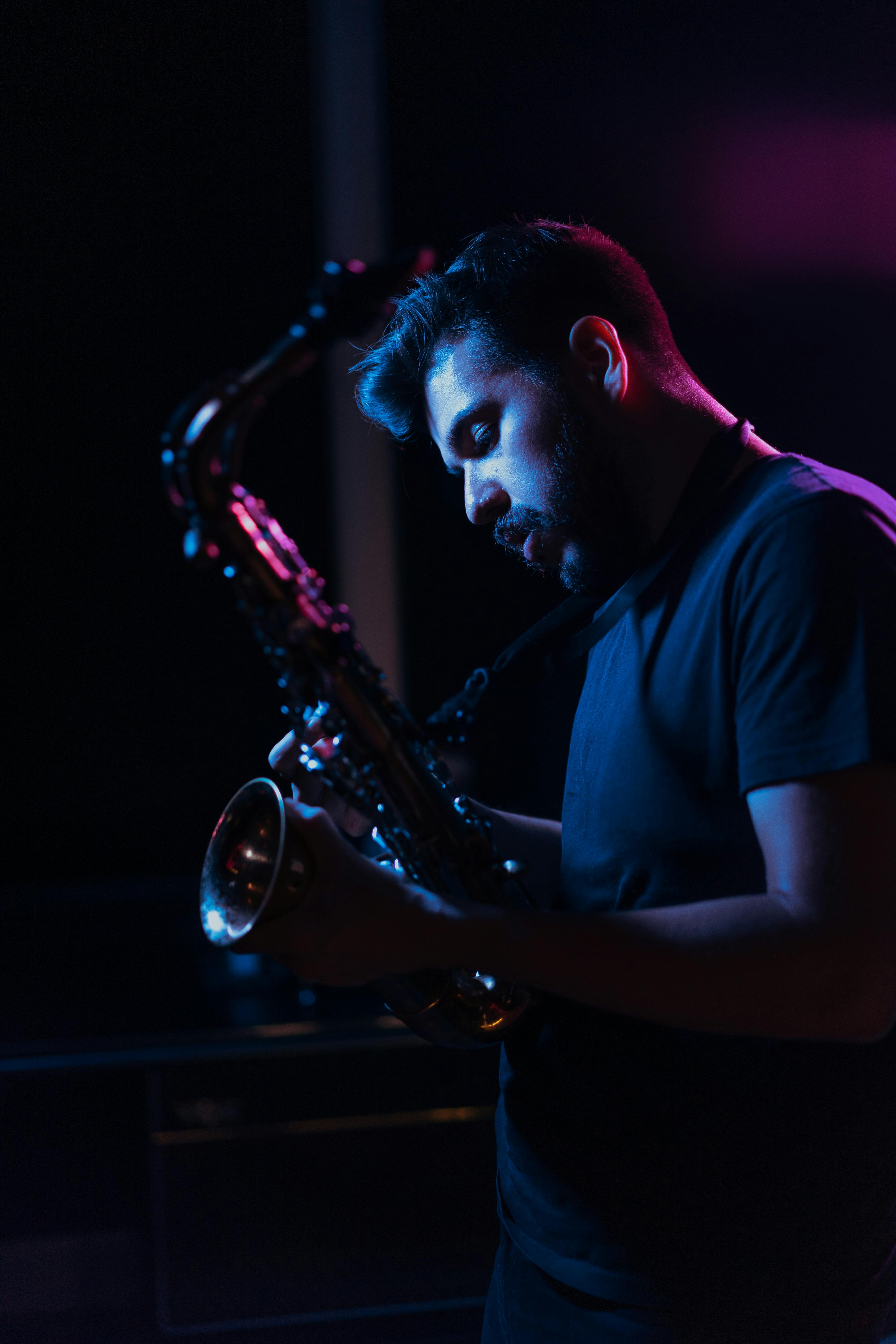 A Man Holding a Saxophone · Free Stock Photo