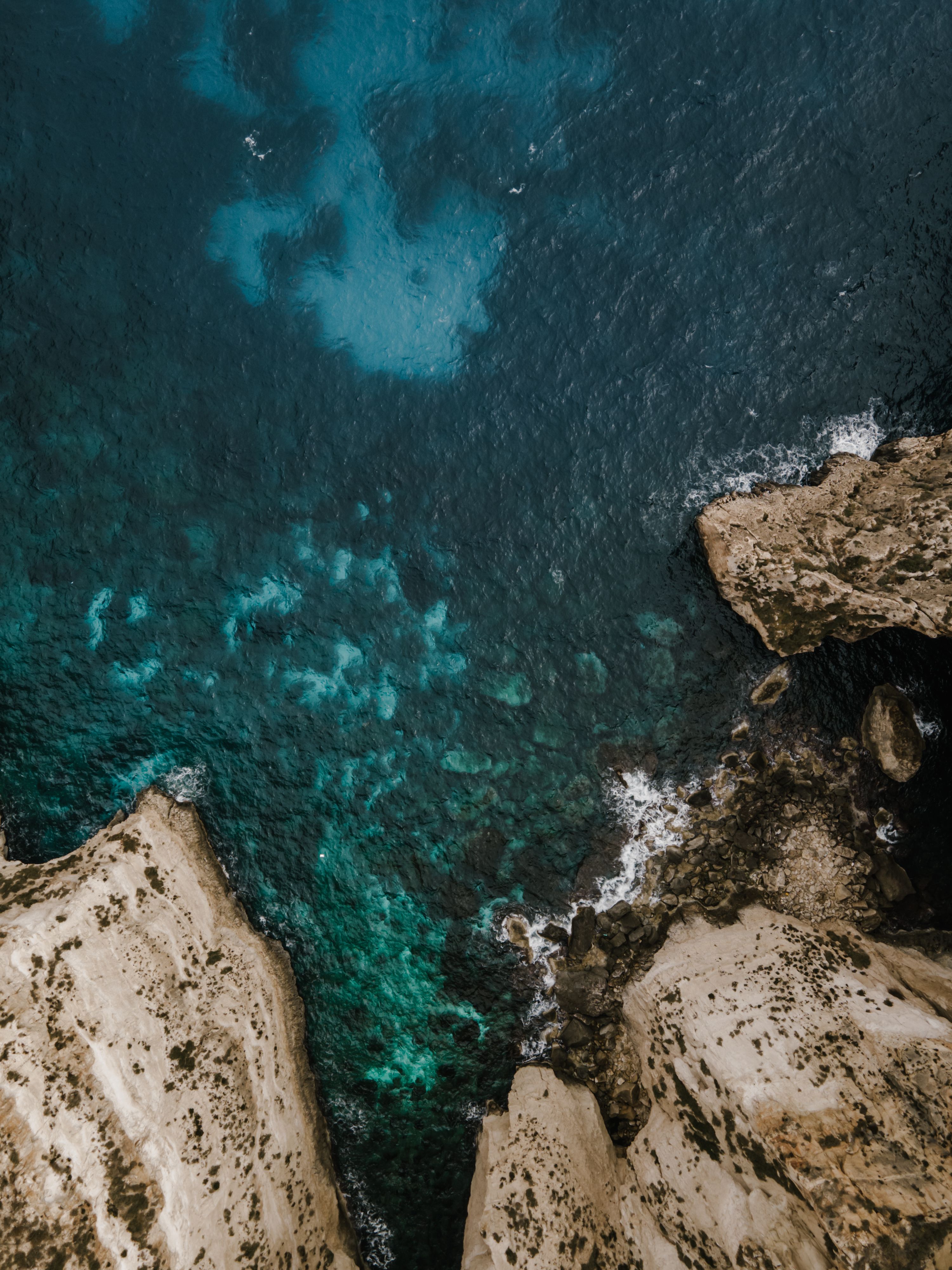 Aerial Footage of Rocky Cliffs on Seacoast · Free Stock Photo