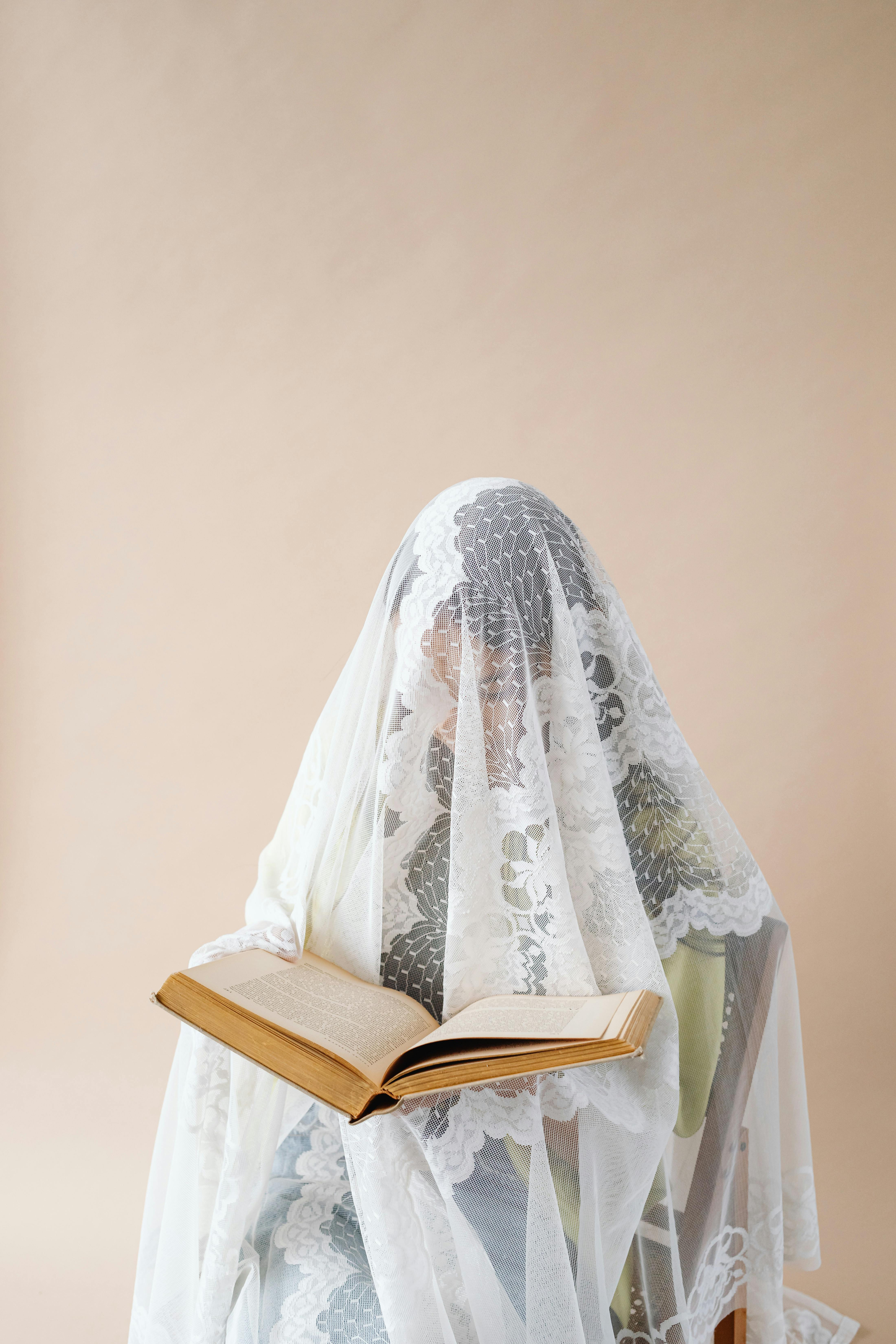 Person reading Book wearing White Lace Veil · Free Stock Photo