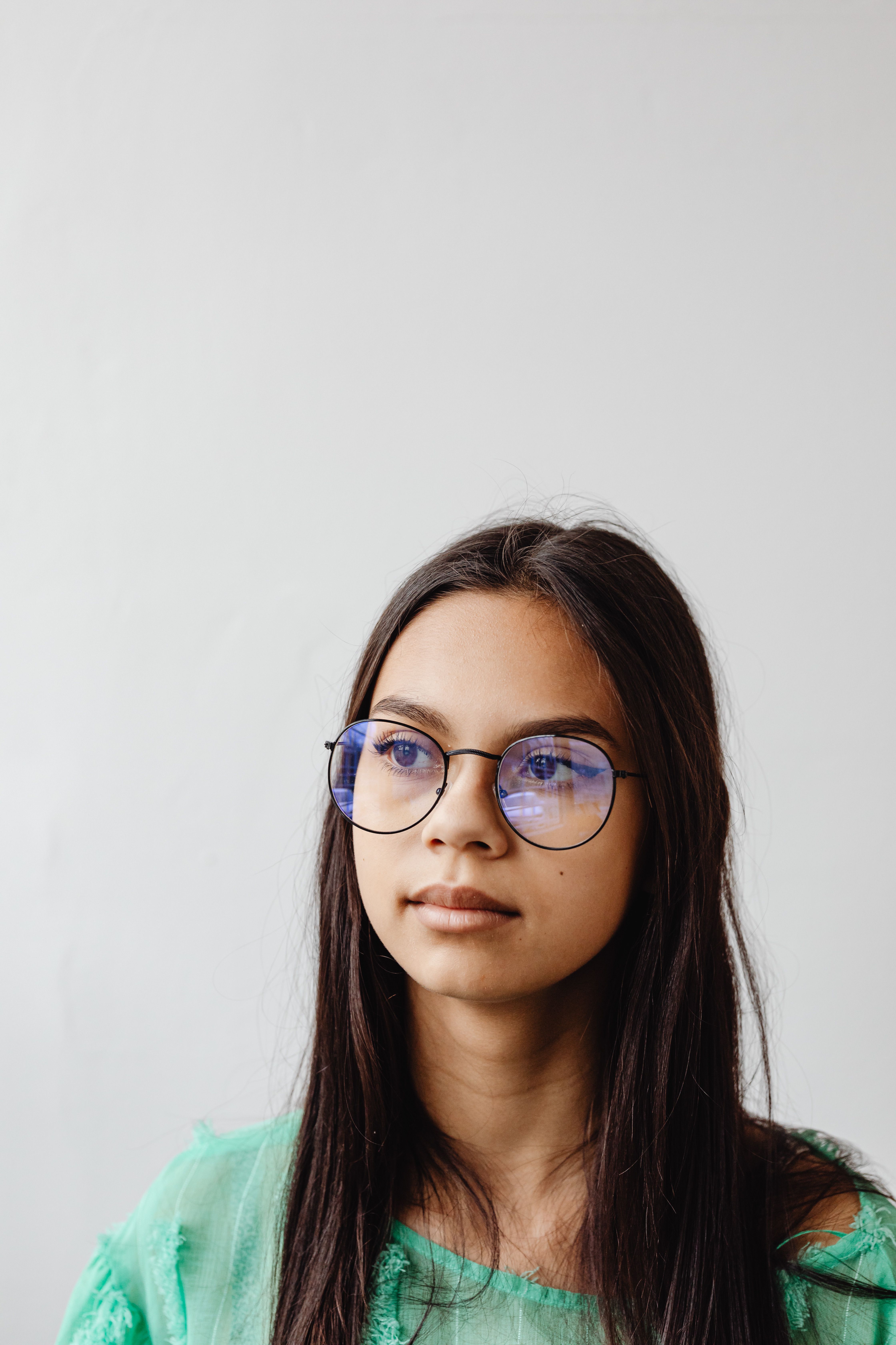 Studio Portrait of a Teenage Girl in Eyeglasses · Free Stock Photo