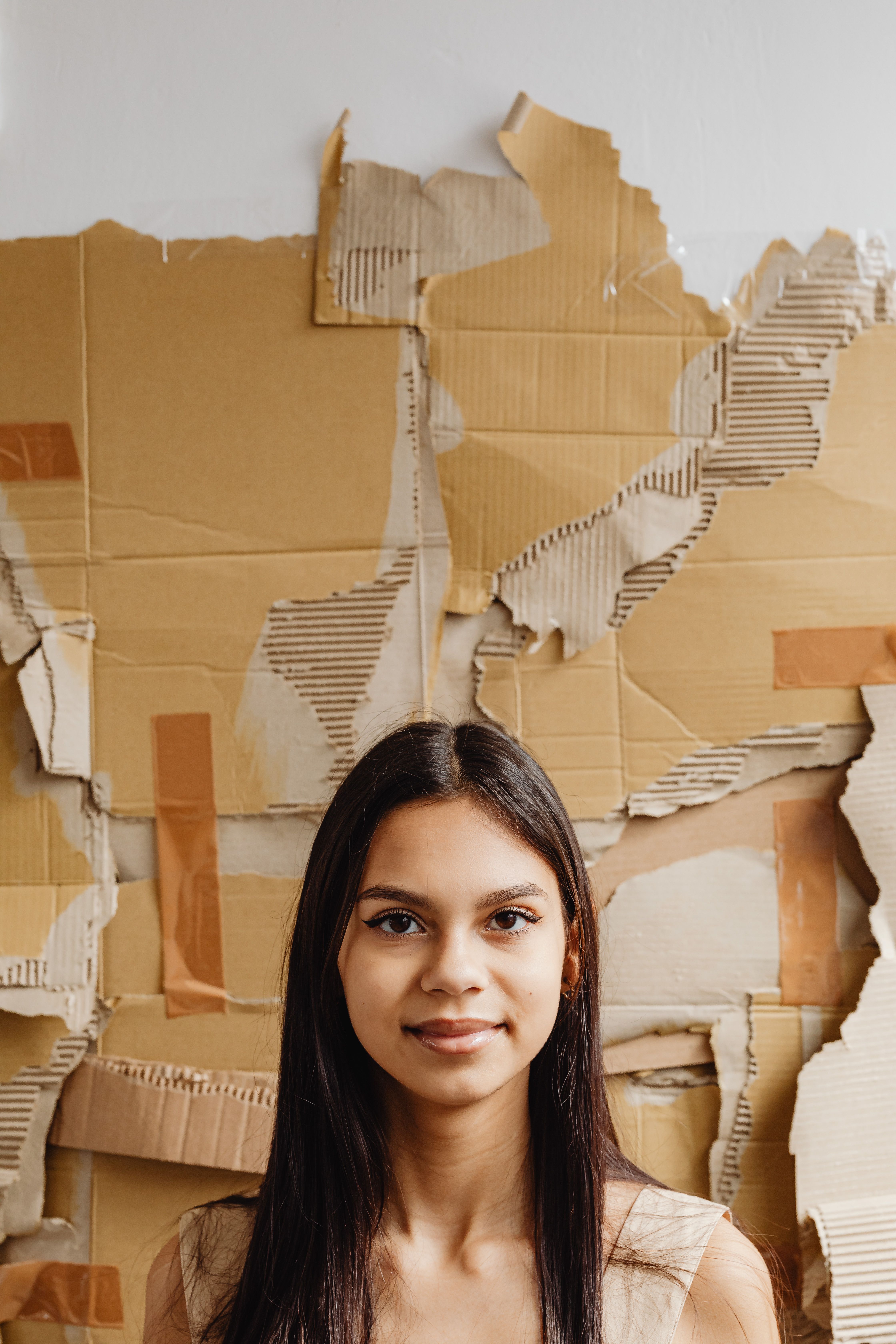 Woman Smiling, Cardboard on Wall · Free Stock Photo