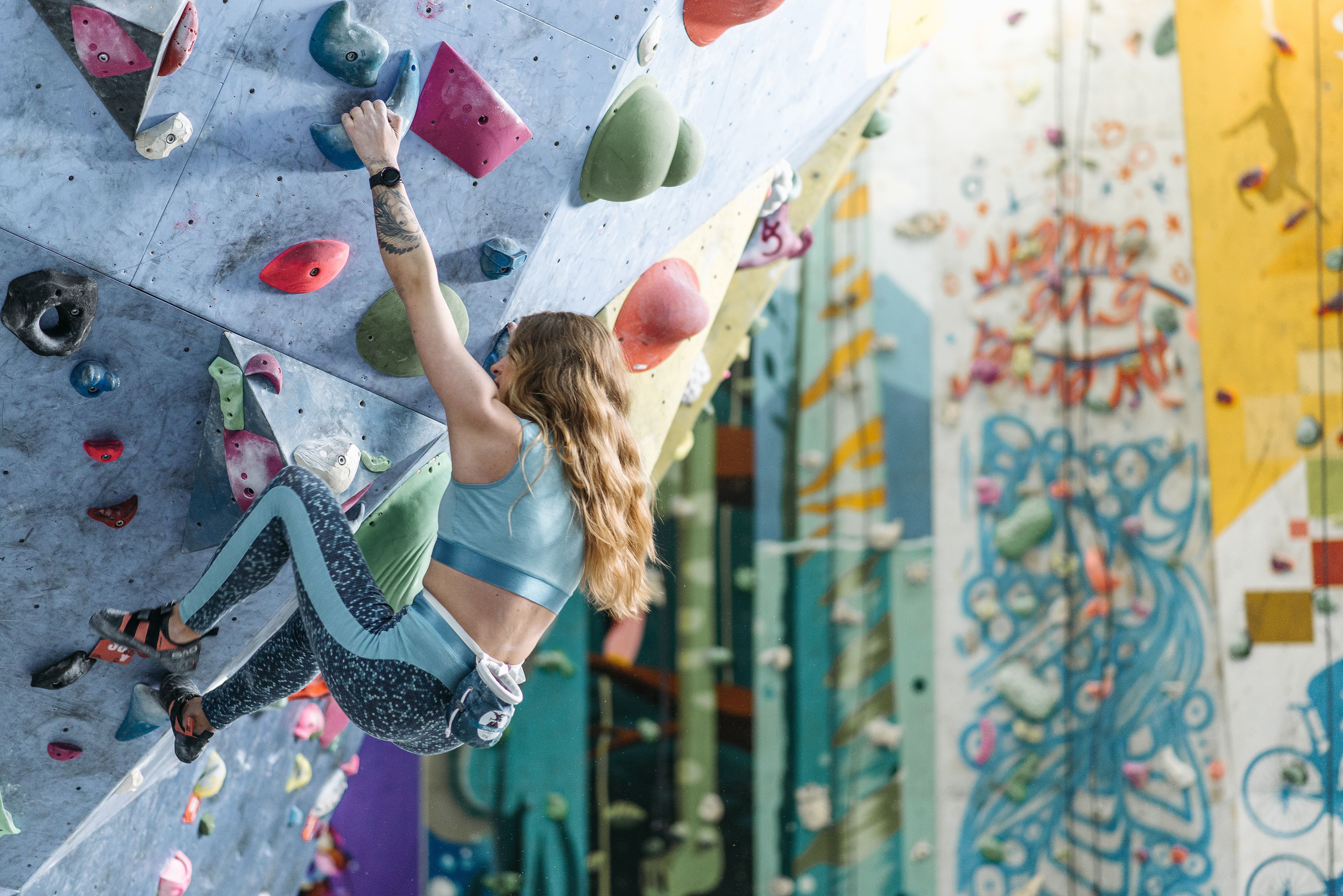 A Woman Climbing on the Wall · Free Stock Photo