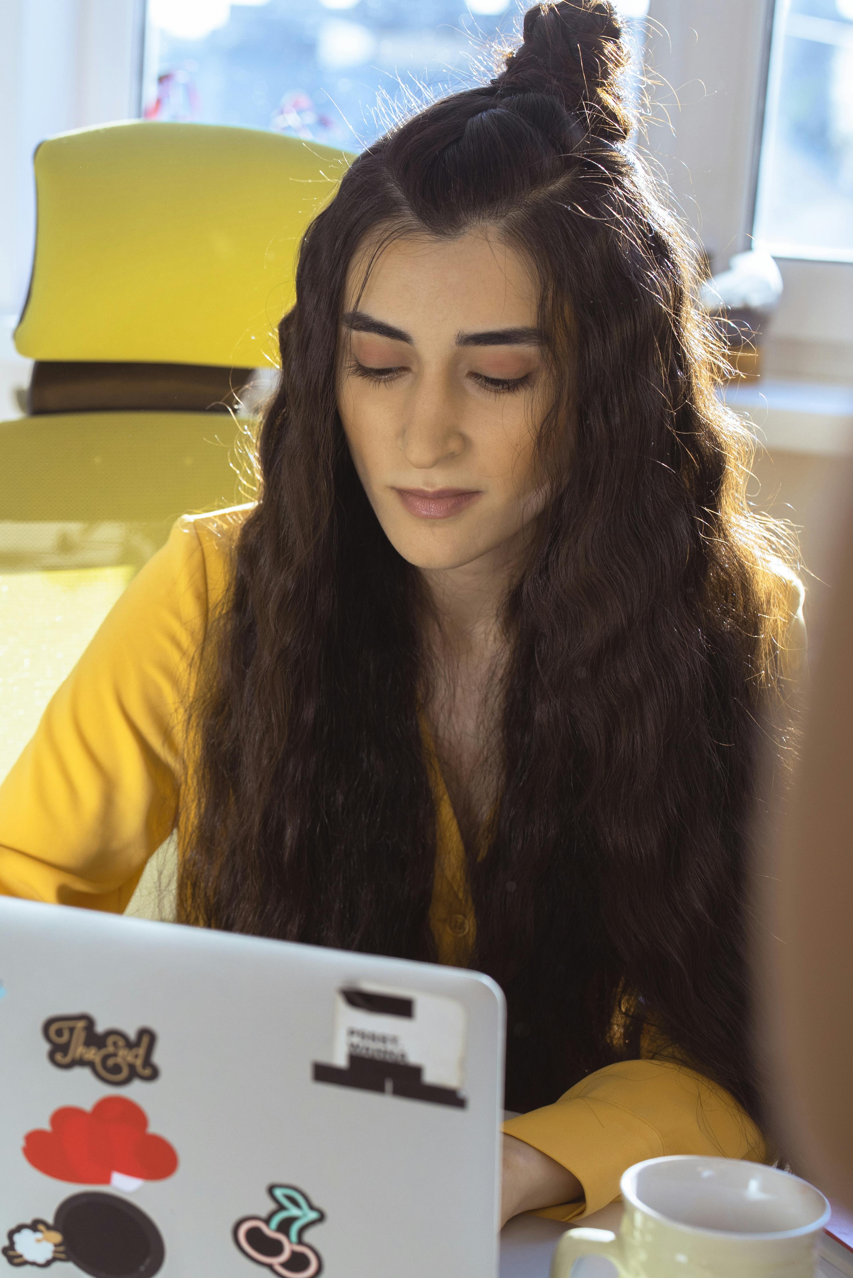 A Woman with Long Hair Using Laptop · Free Stock Photo