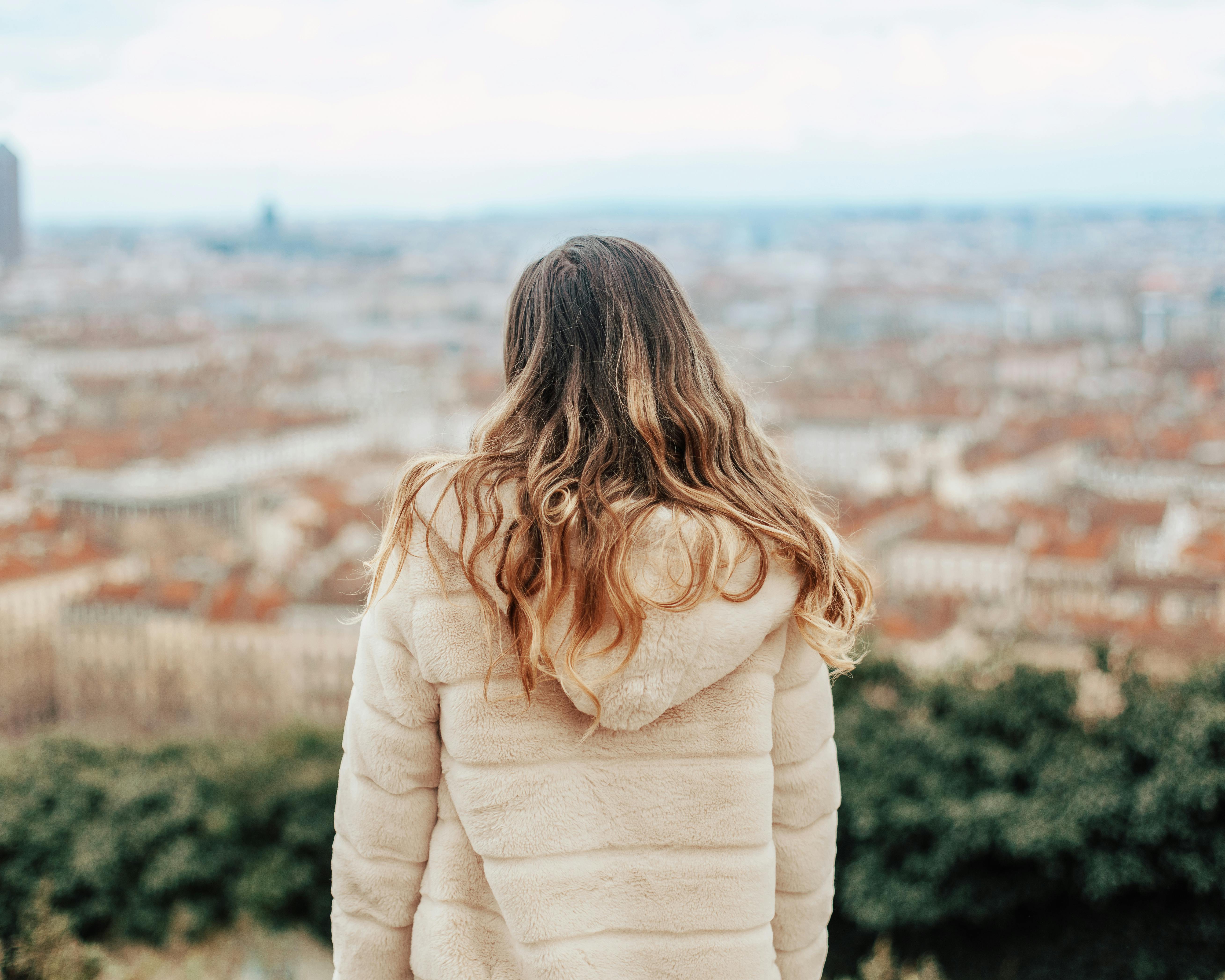 Back View of a Woman Wearing Winter Hoodie · Free Stock Photo
