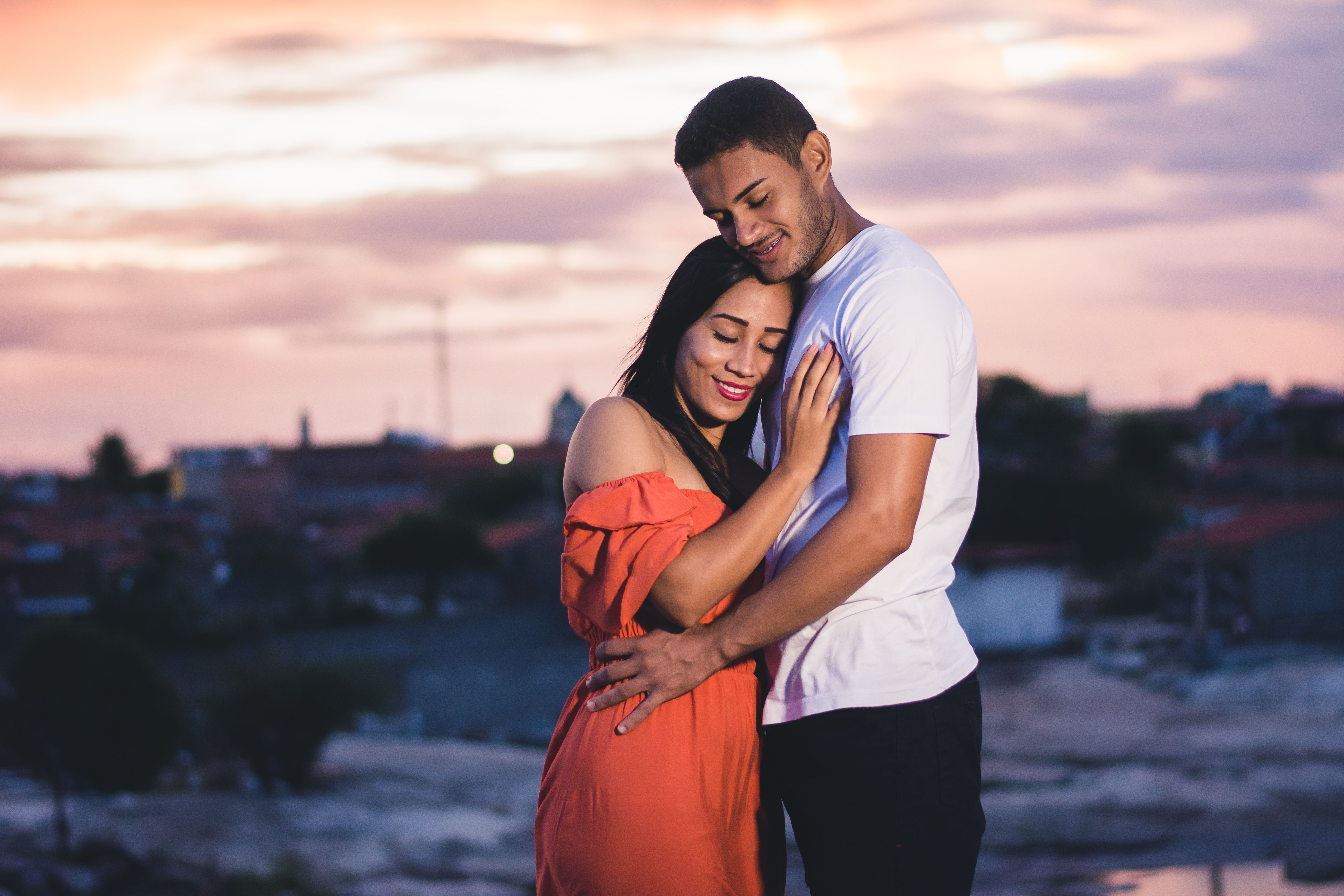 A Couple Hugging Each Other with their Eyes Closed · Free Stock Photo