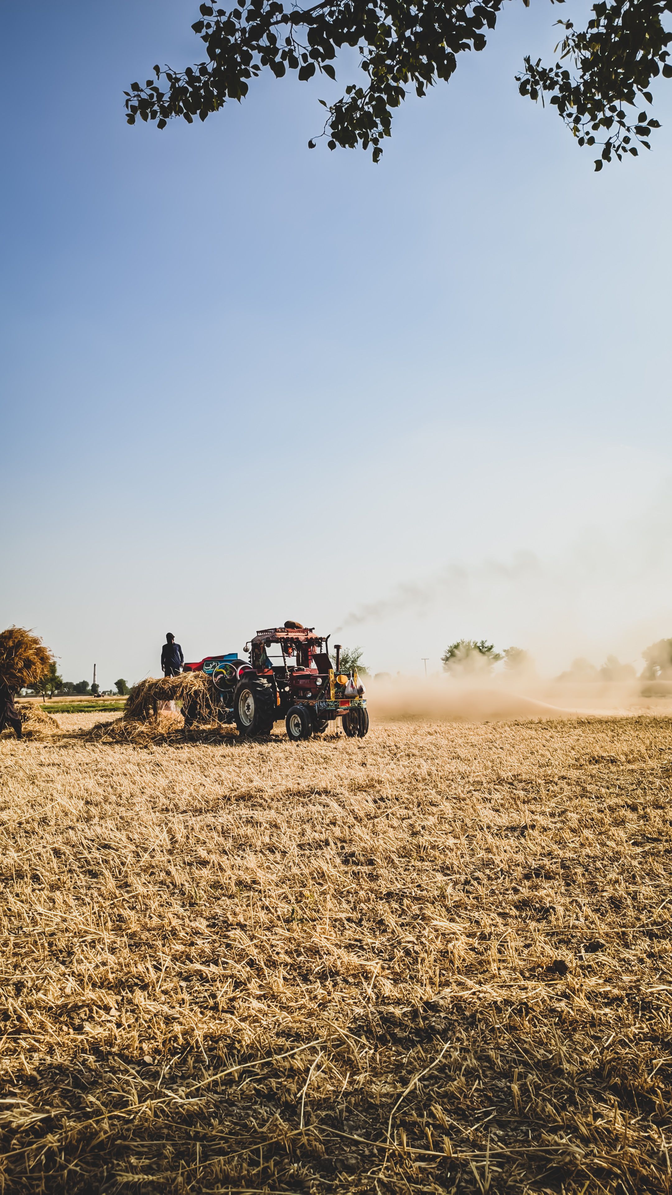 Blue Tractor Next to White Farm Vehicle at Daytime · Free Stock Photo