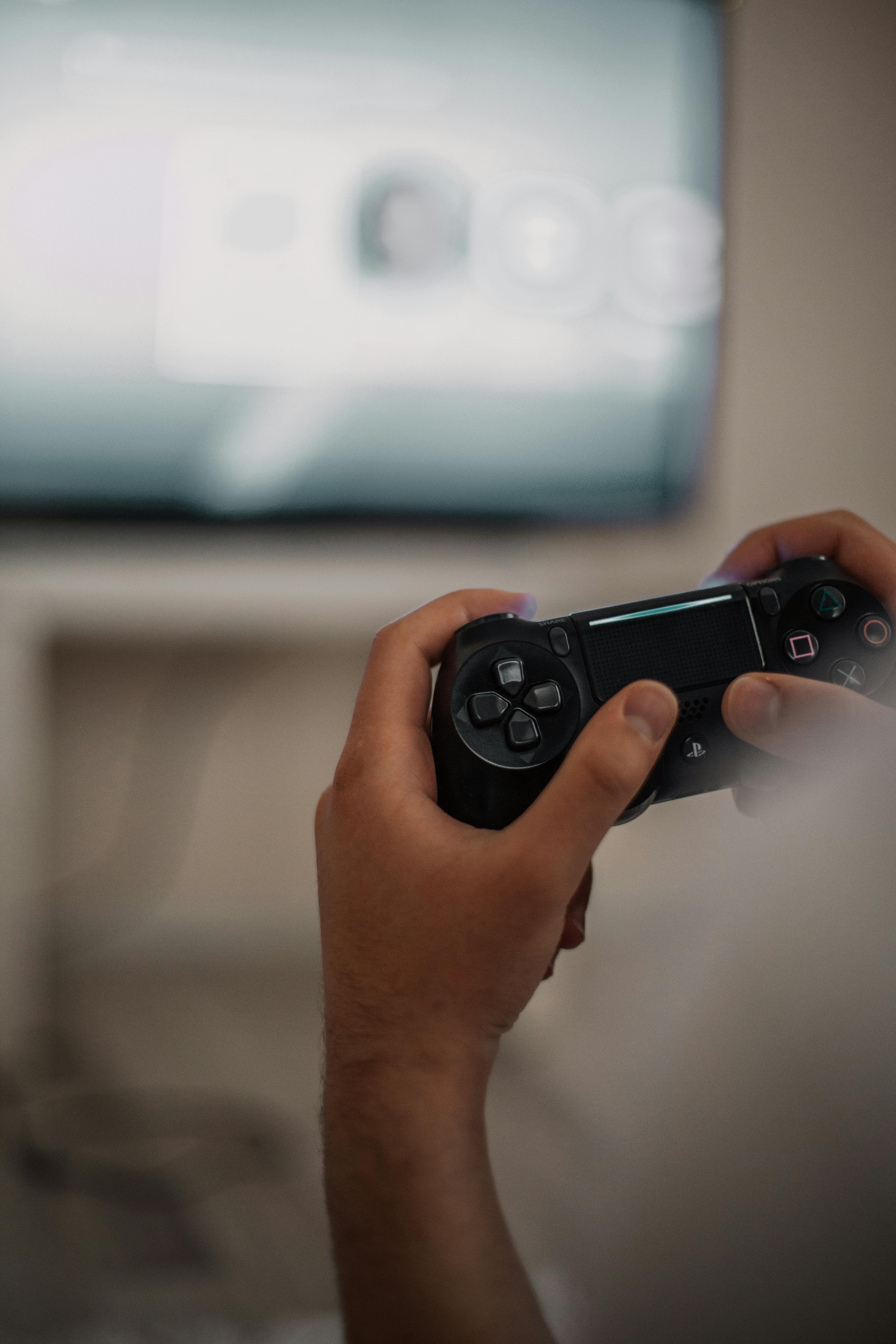 Person Holding Black Game Controller · Free Stock Photo
