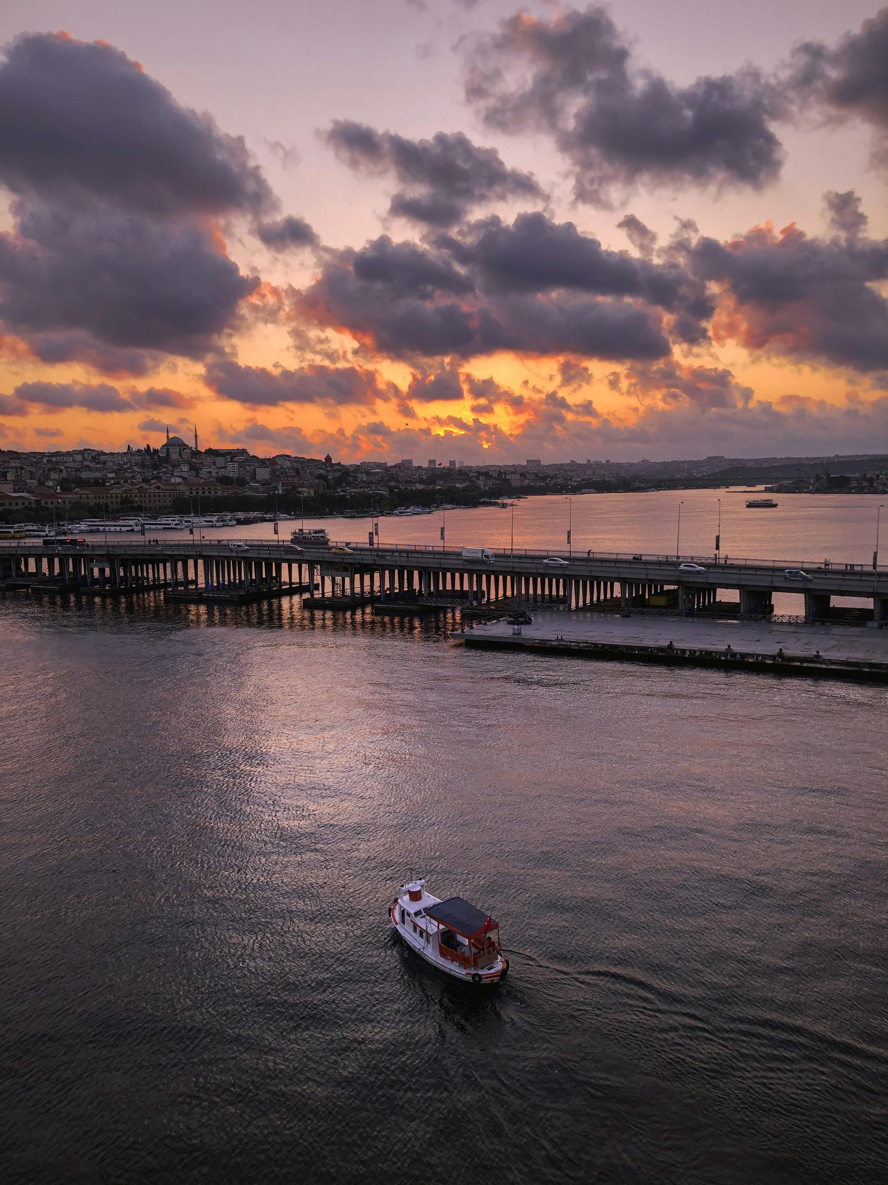 Boat Sailing on the River Near the Bridge · Free Stock Photo