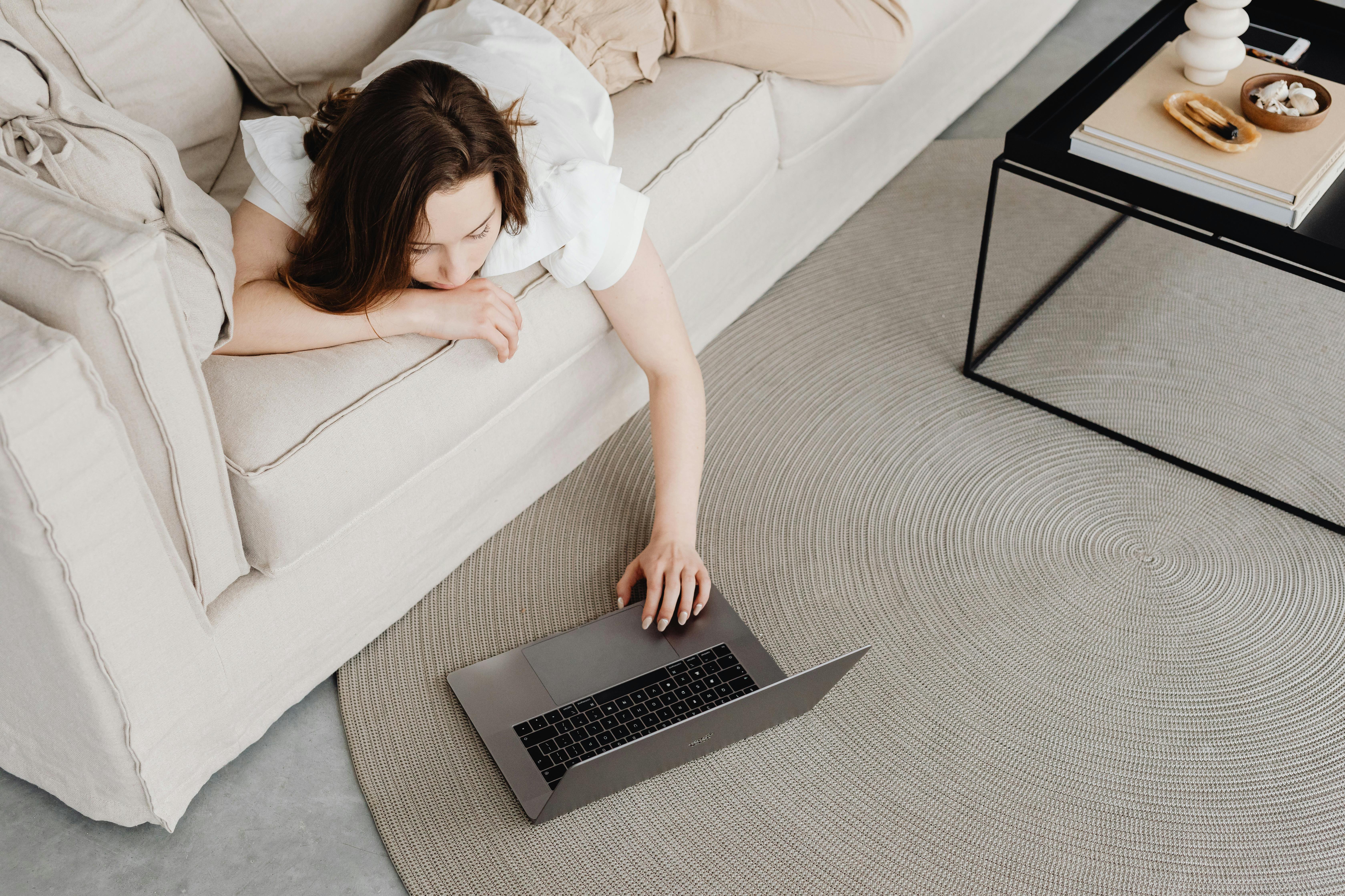 Woman using Gray Laptop on the Floor · Free Stock Photo