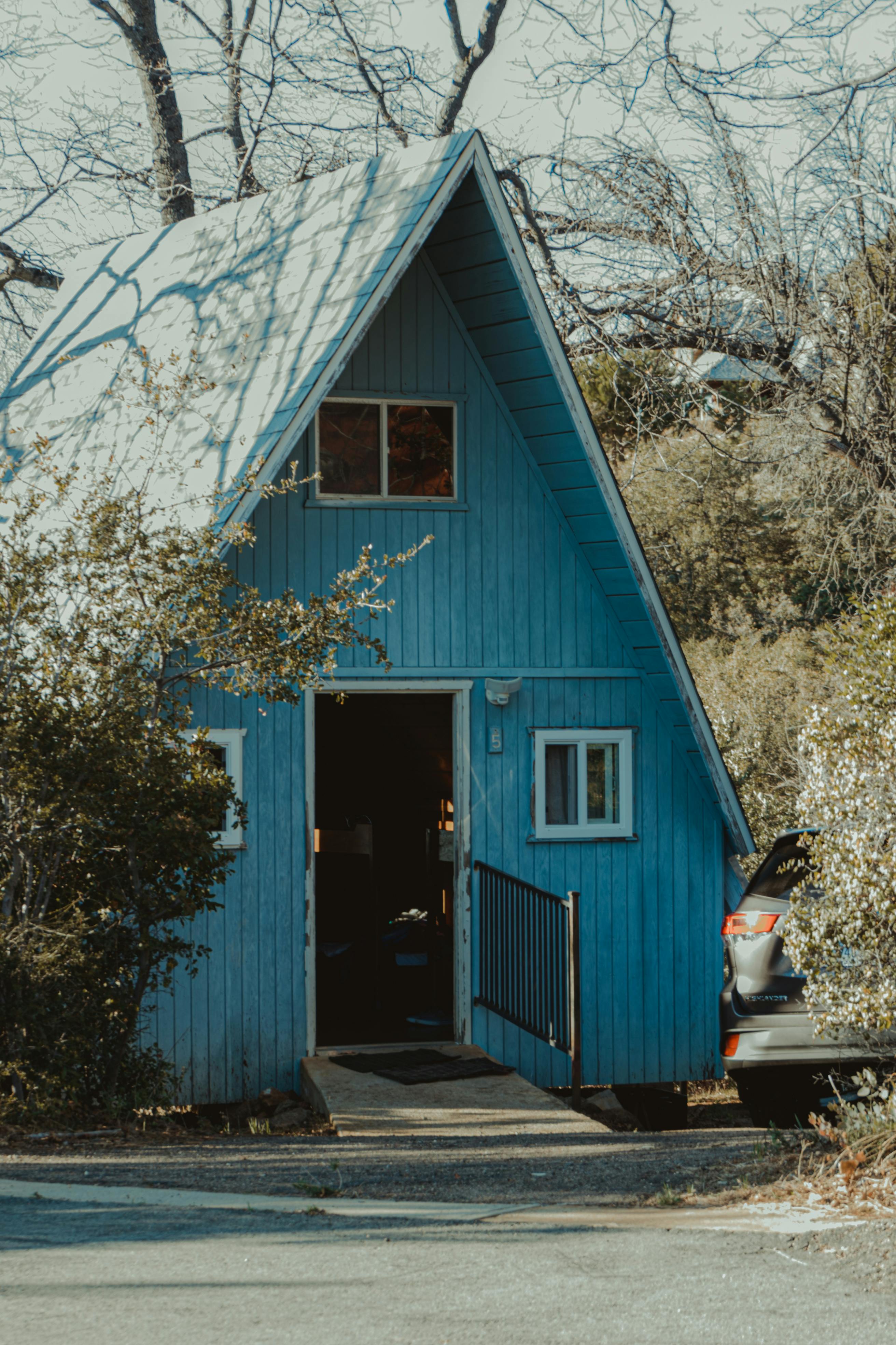 A Blue House Surrounded by Trees · Free Stock Photo