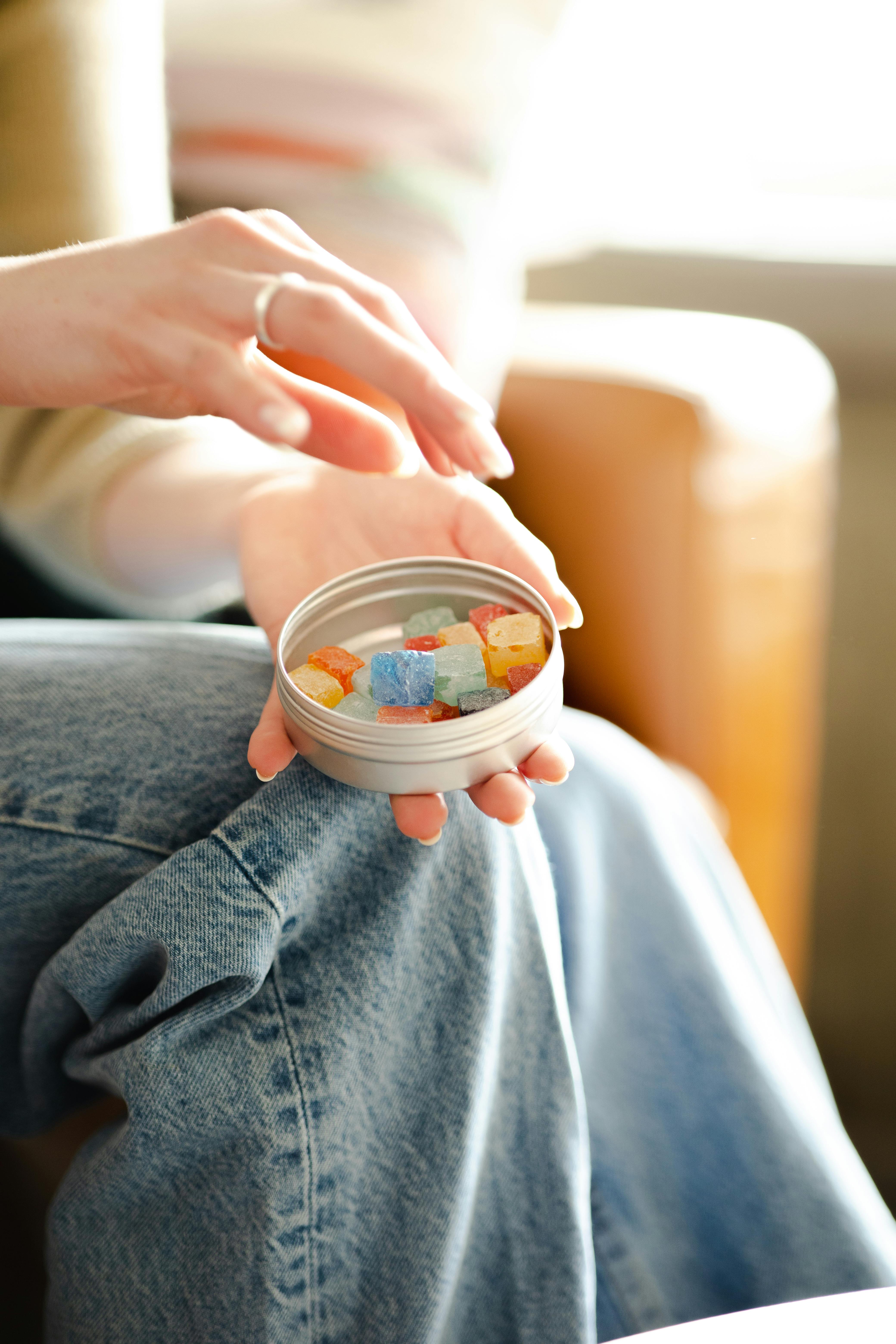 Person Holding a Can of Colorful Candies · Free Stock Photo