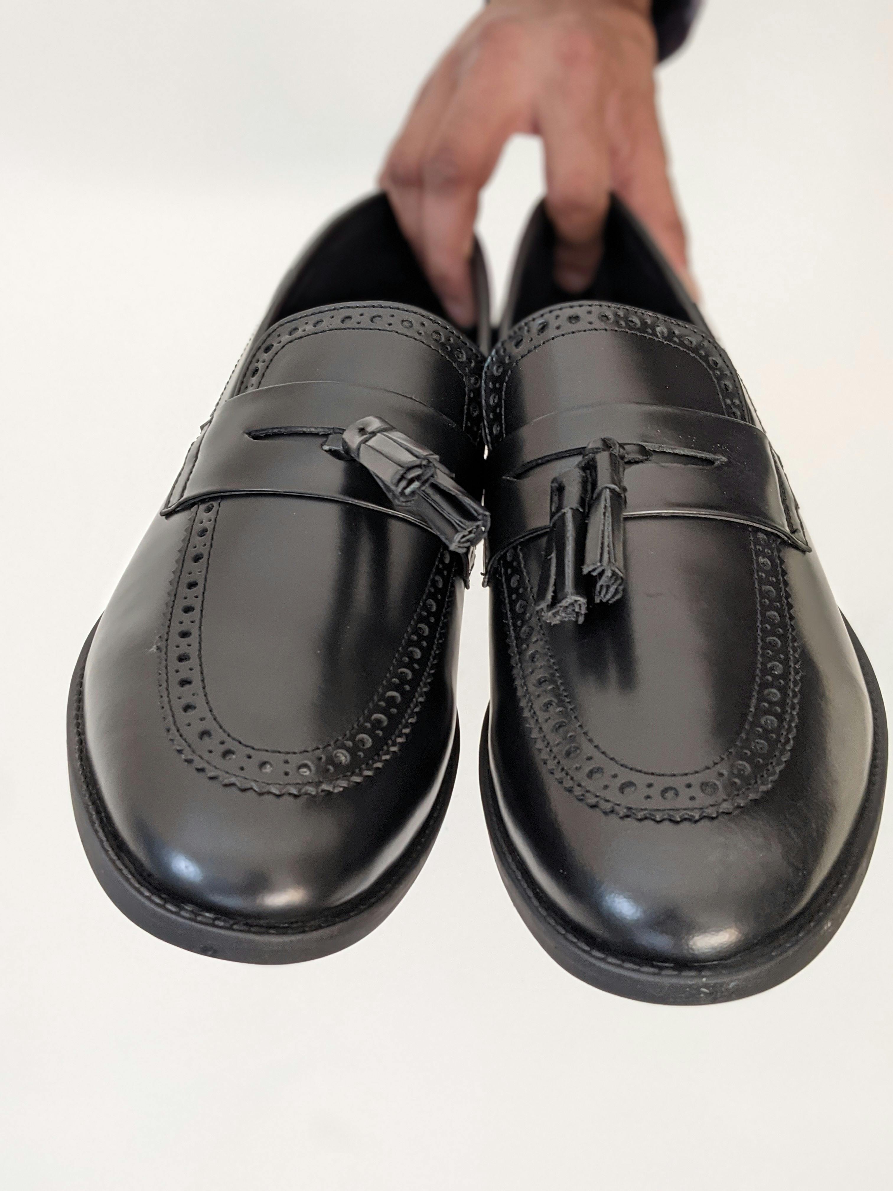 Hand Holding Shoes · Free Stock Photo