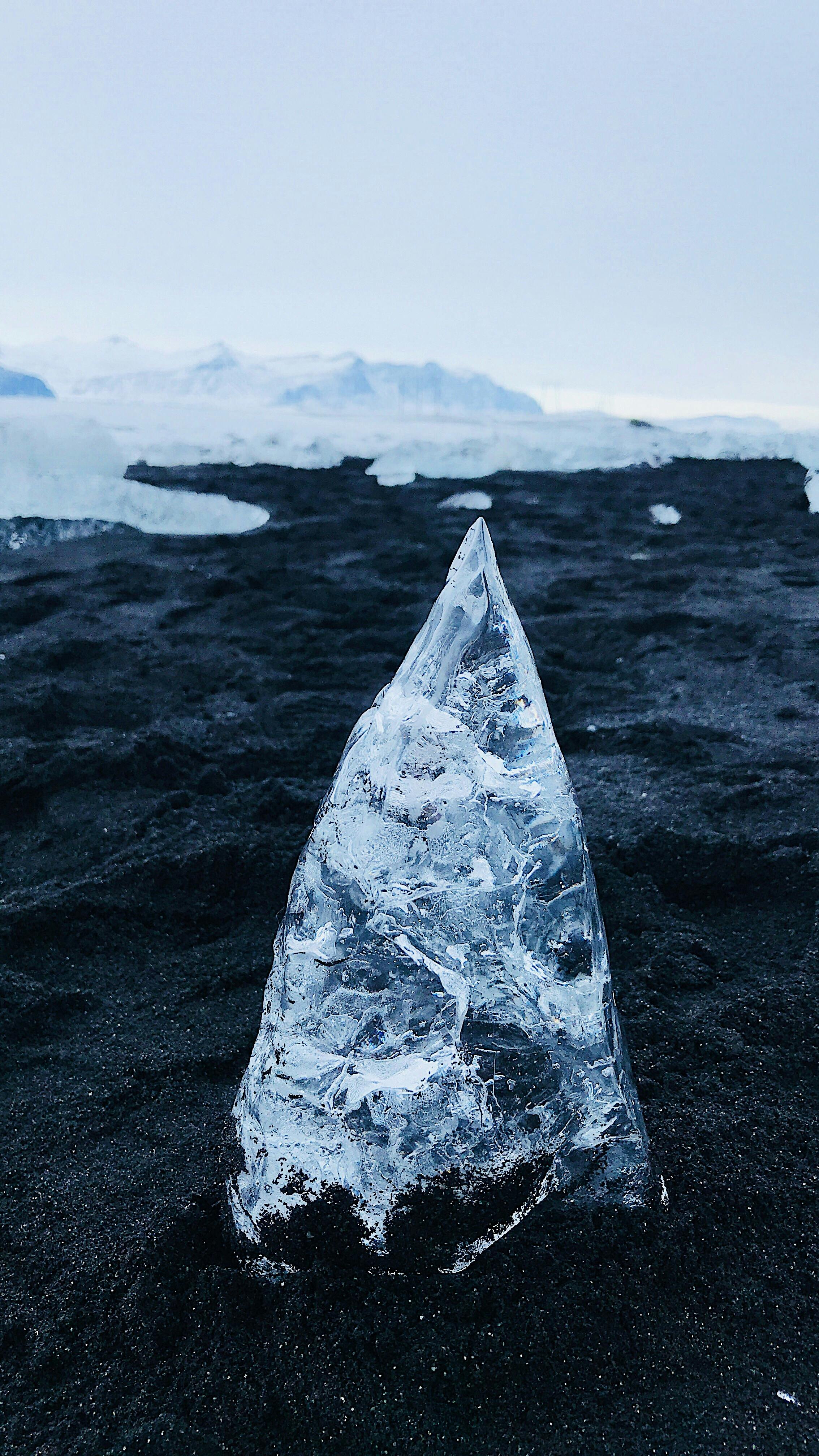 Ice Stone on Black Sand · Free Stock Photo
