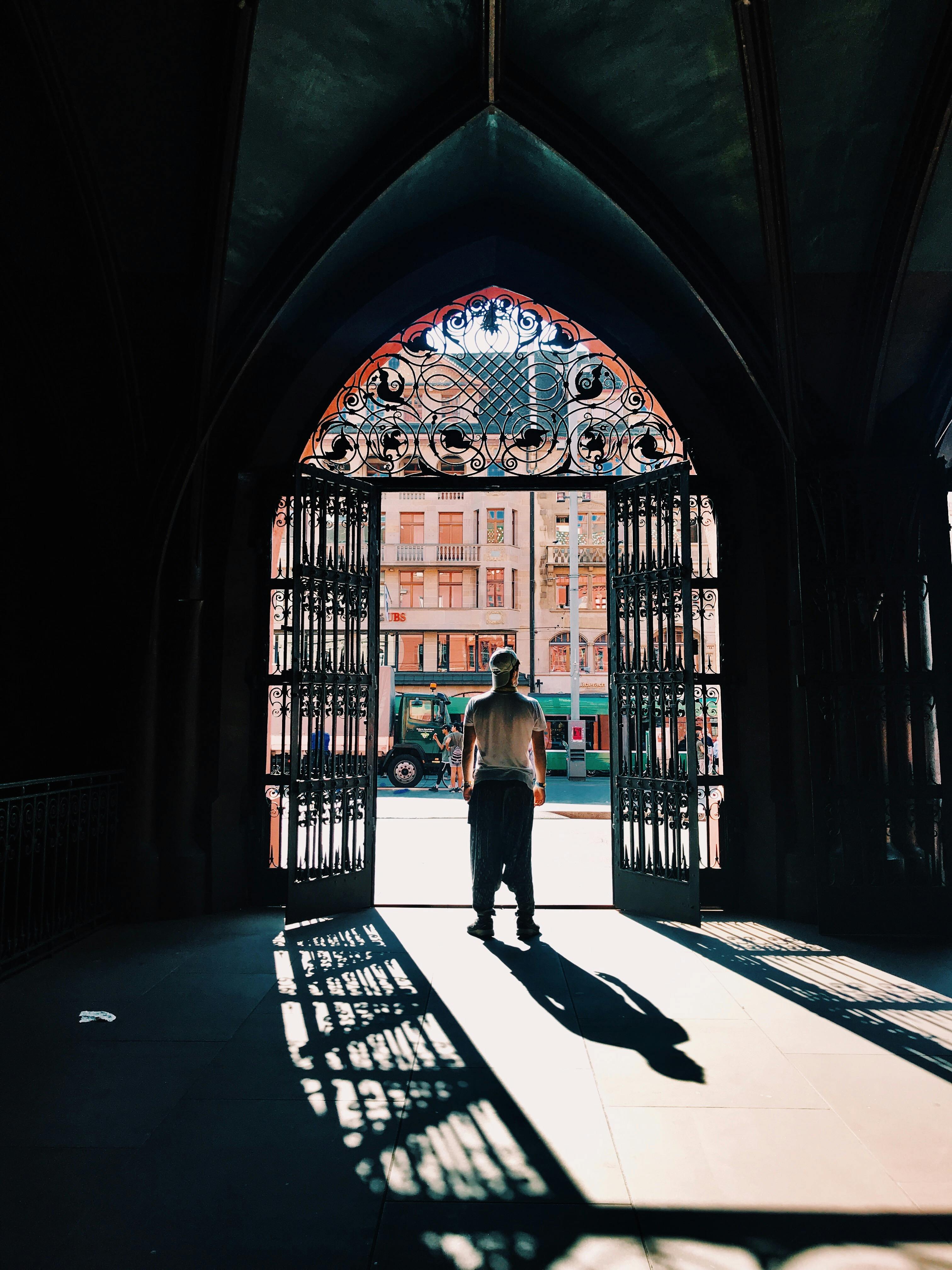 Back View of a Man Standing under a Pointed Arch · Free Stock Photo