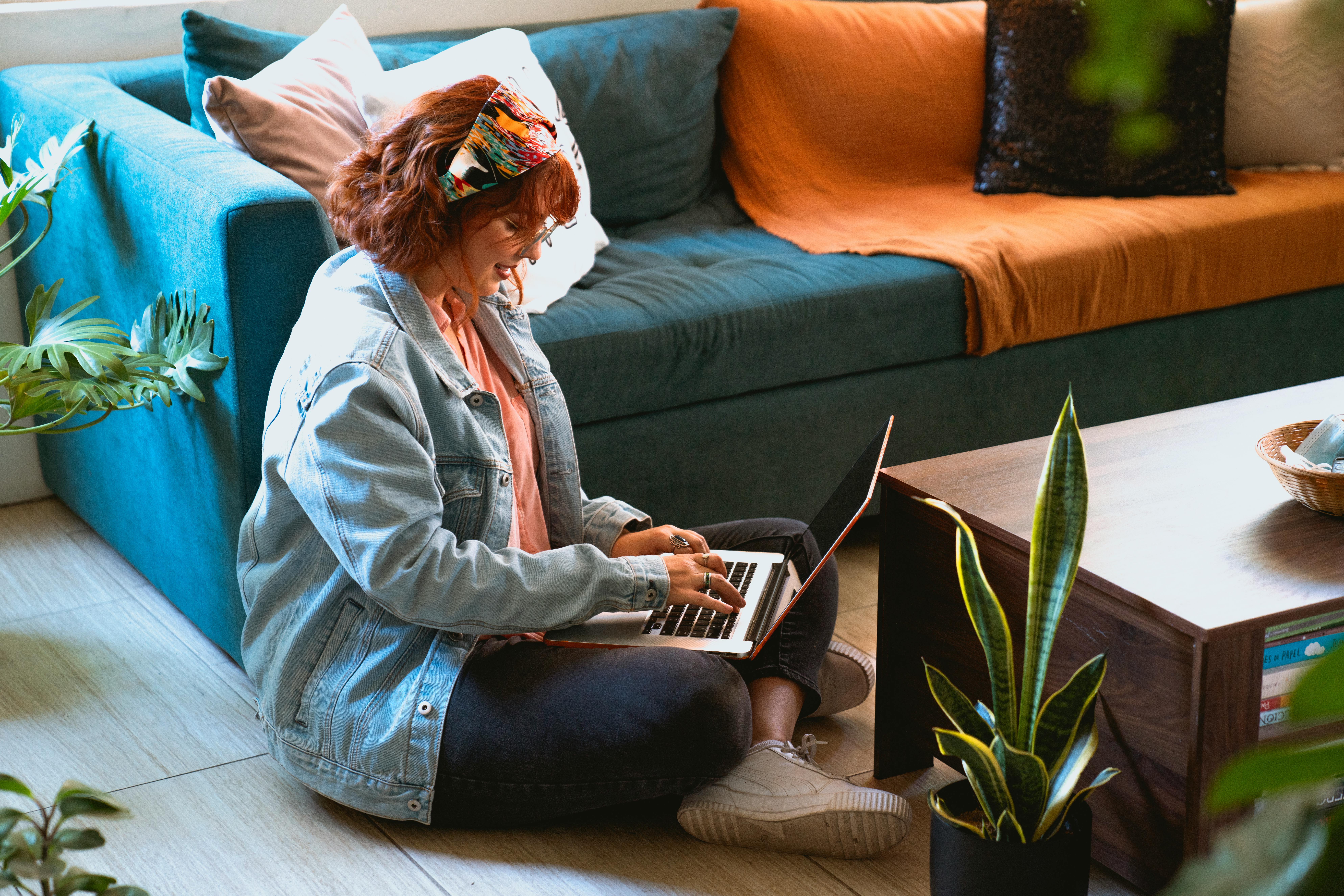 Woman Smiling While Using Laptop · Free Stock Photo