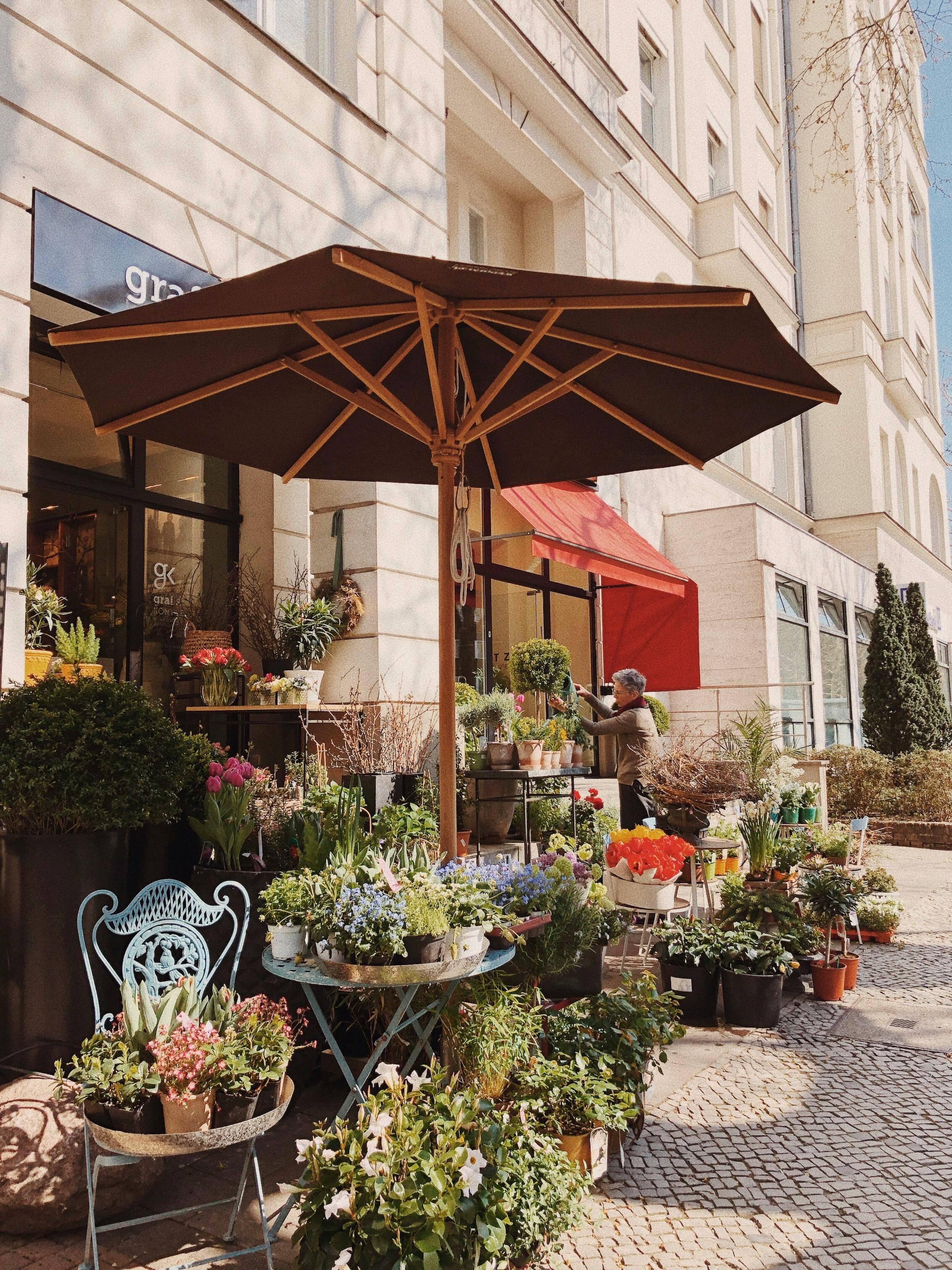 Man Selling Flowers on Sidewalk · Free Stock Photo
