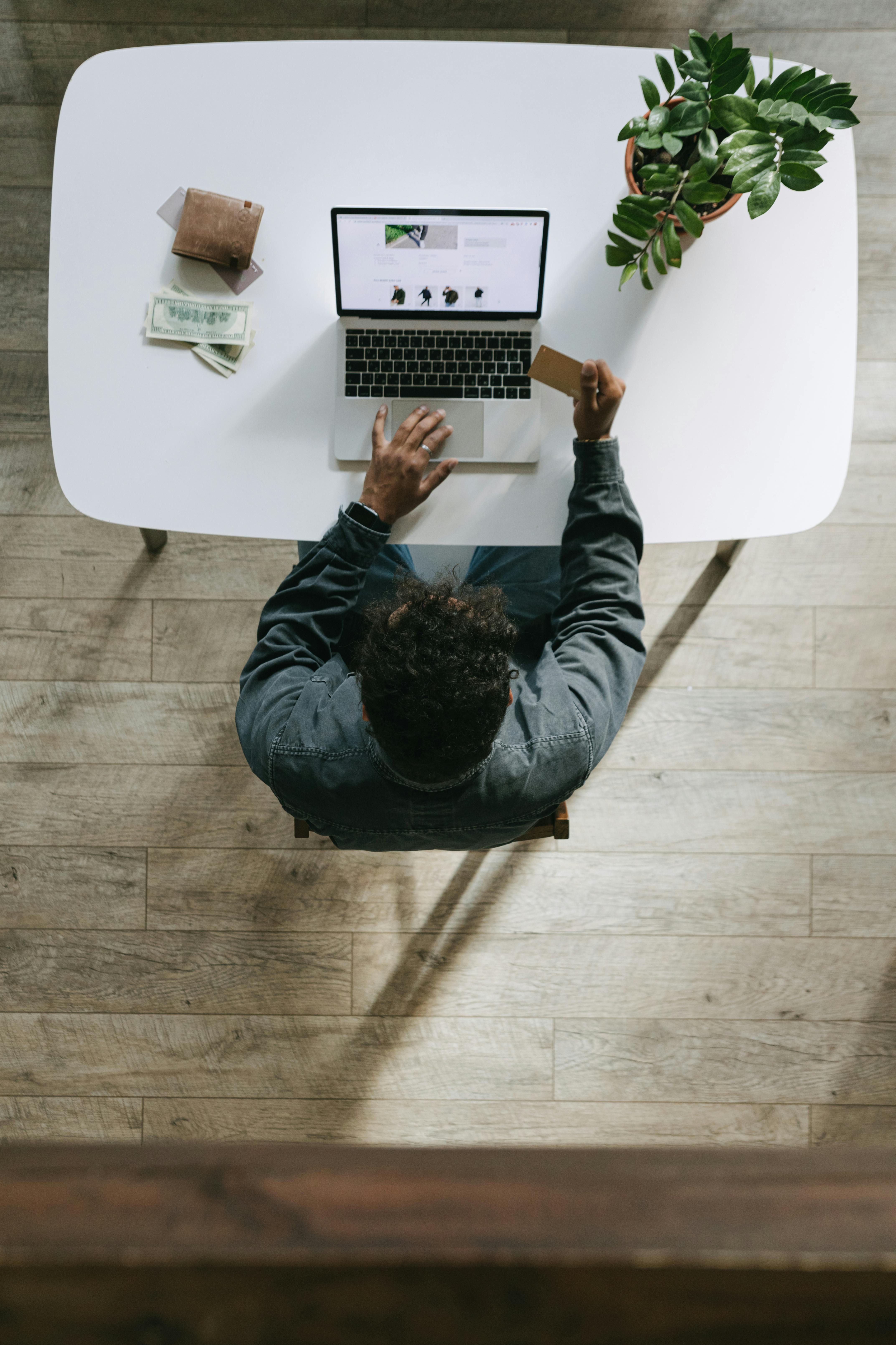Person using laptop on White Table · Free Stock Photo
