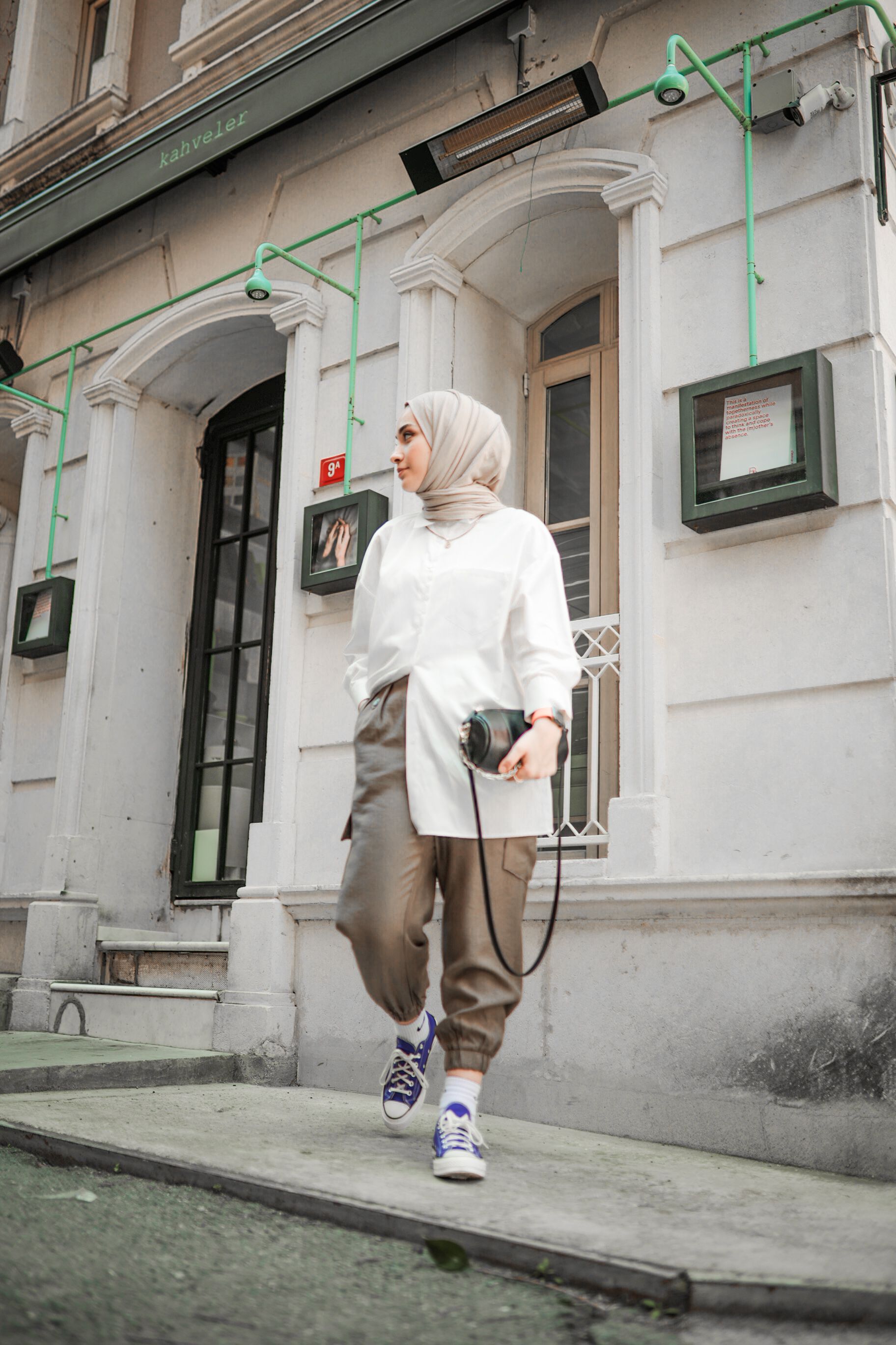 A Stylish Woman Standing on Sidewalk · Free Stock Photo