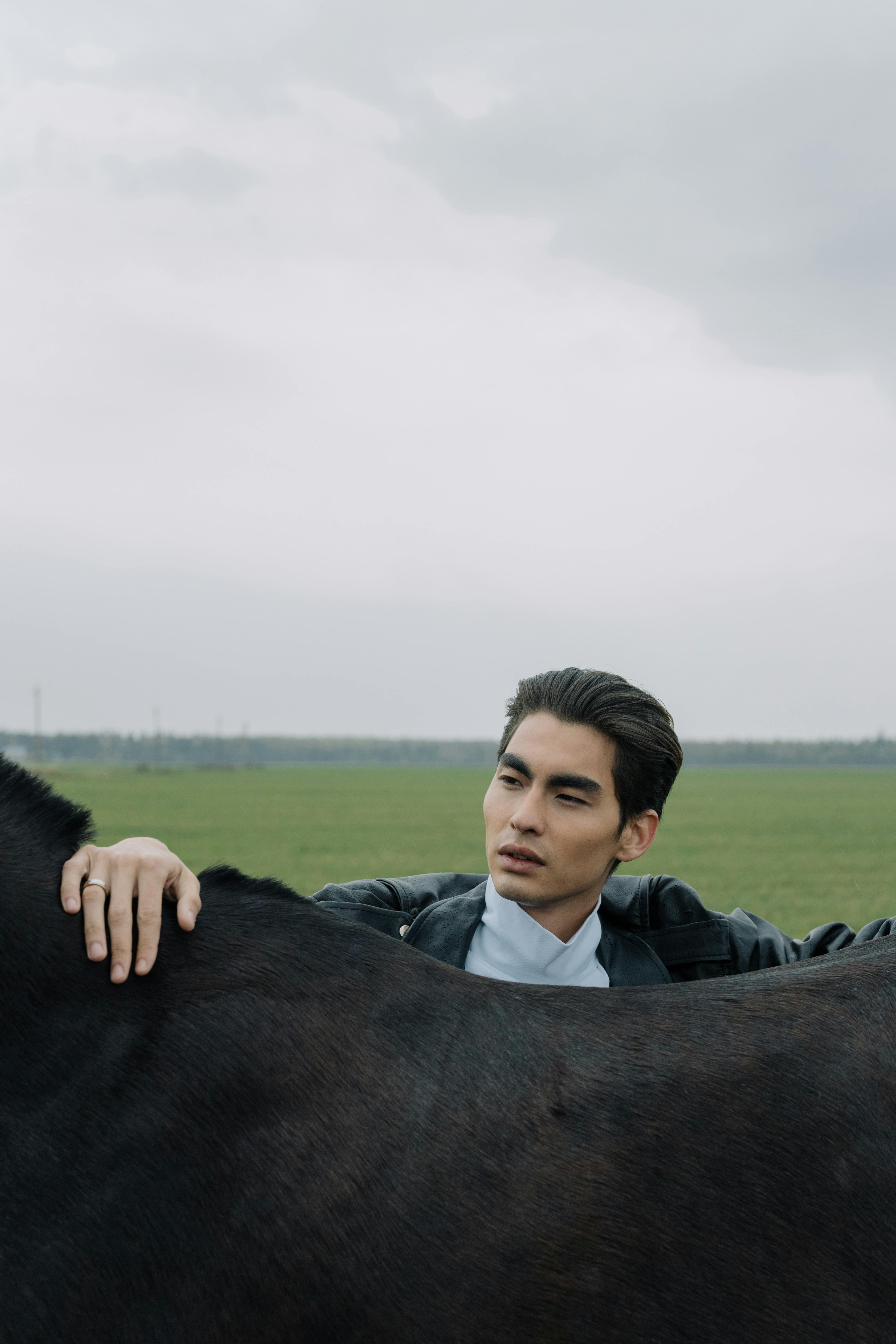 A Handsome Man Holding a Horse · Free Stock Photo