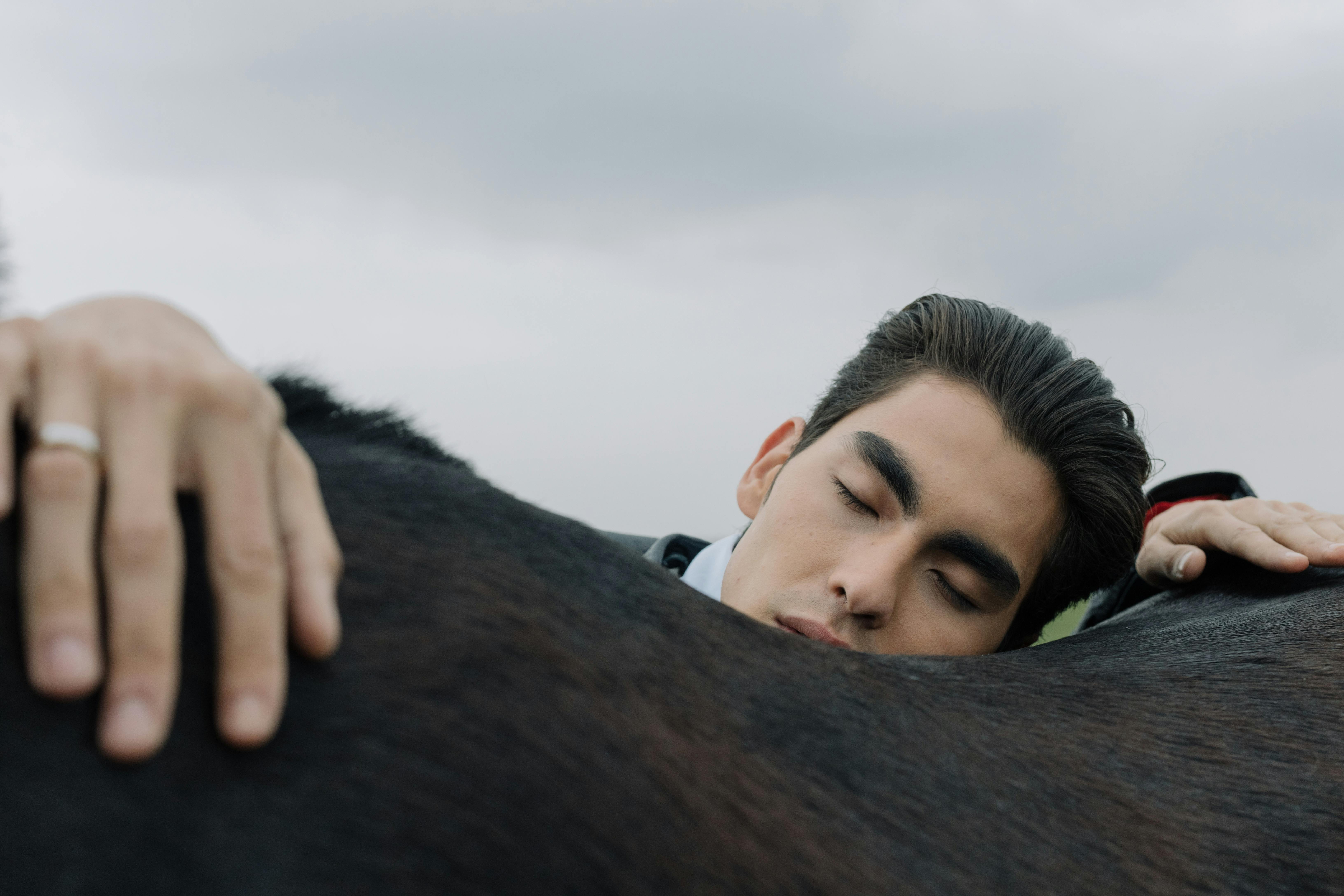 Man Resting Head on an Animal · Free Stock Photo