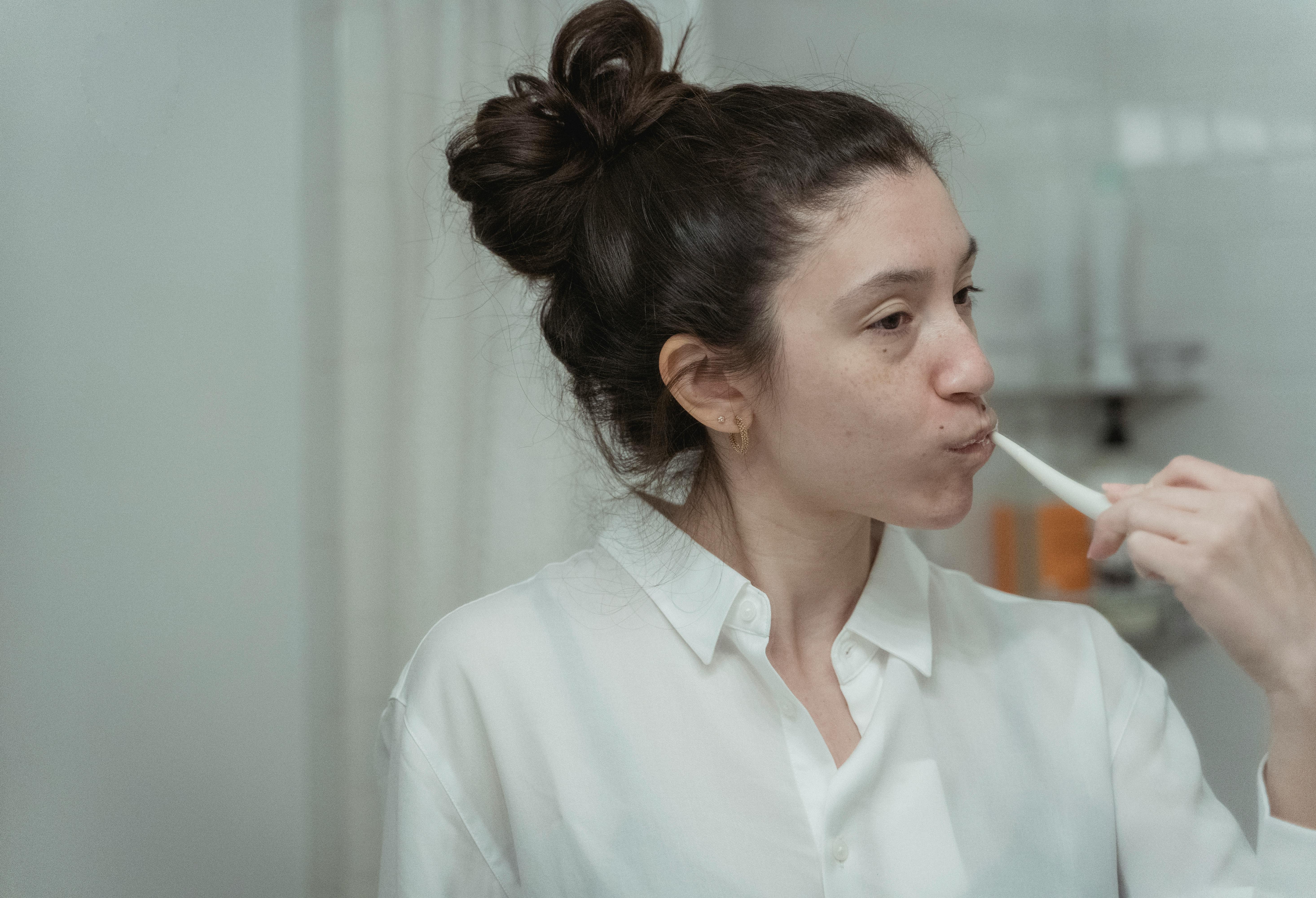 Close-Up Shot of a Person Brushing Her Teeth · Free Stock Photo