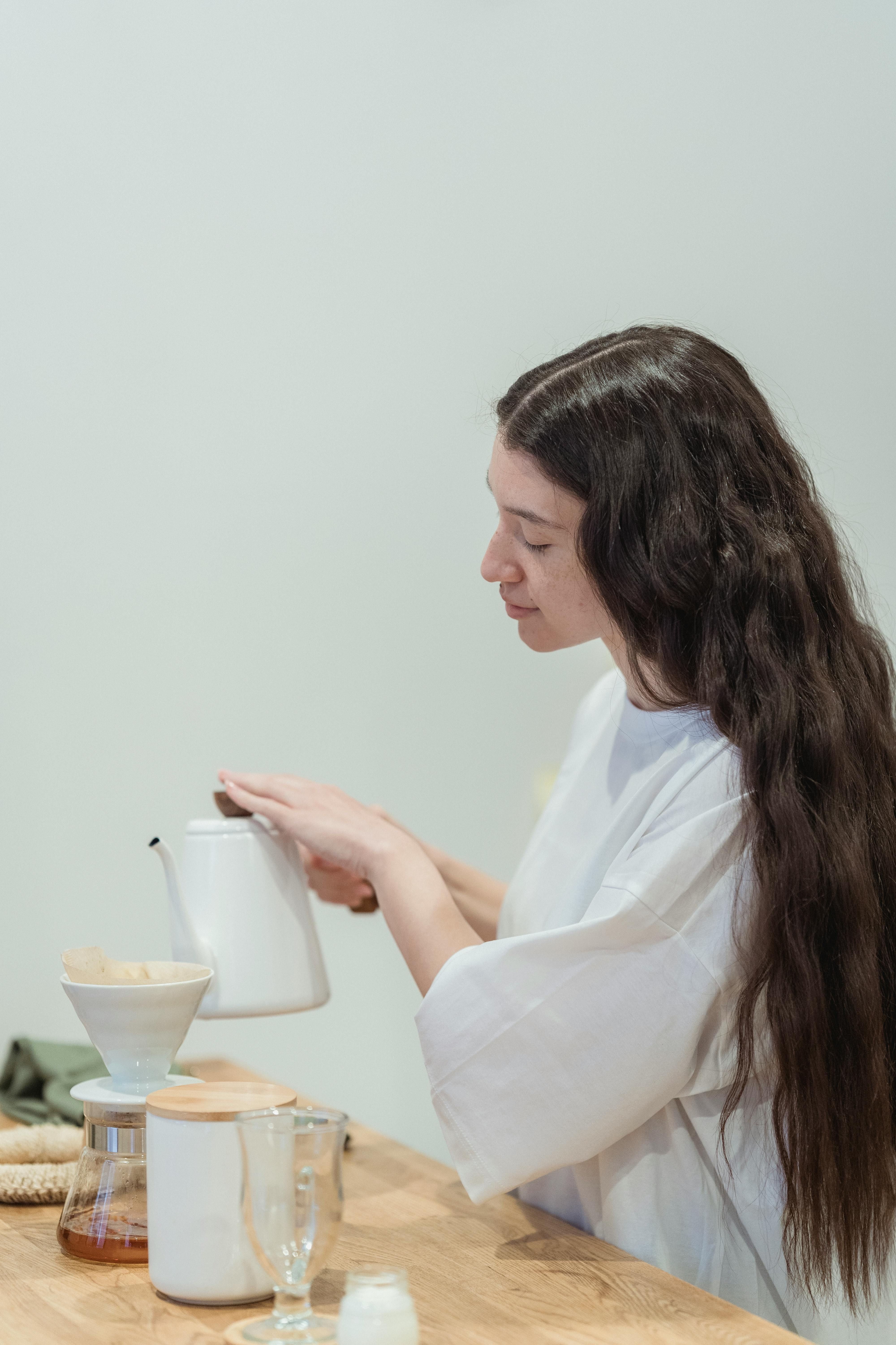 Woman With Long Hair Holding A Teapot Over A Coffee Dripper · Free ...