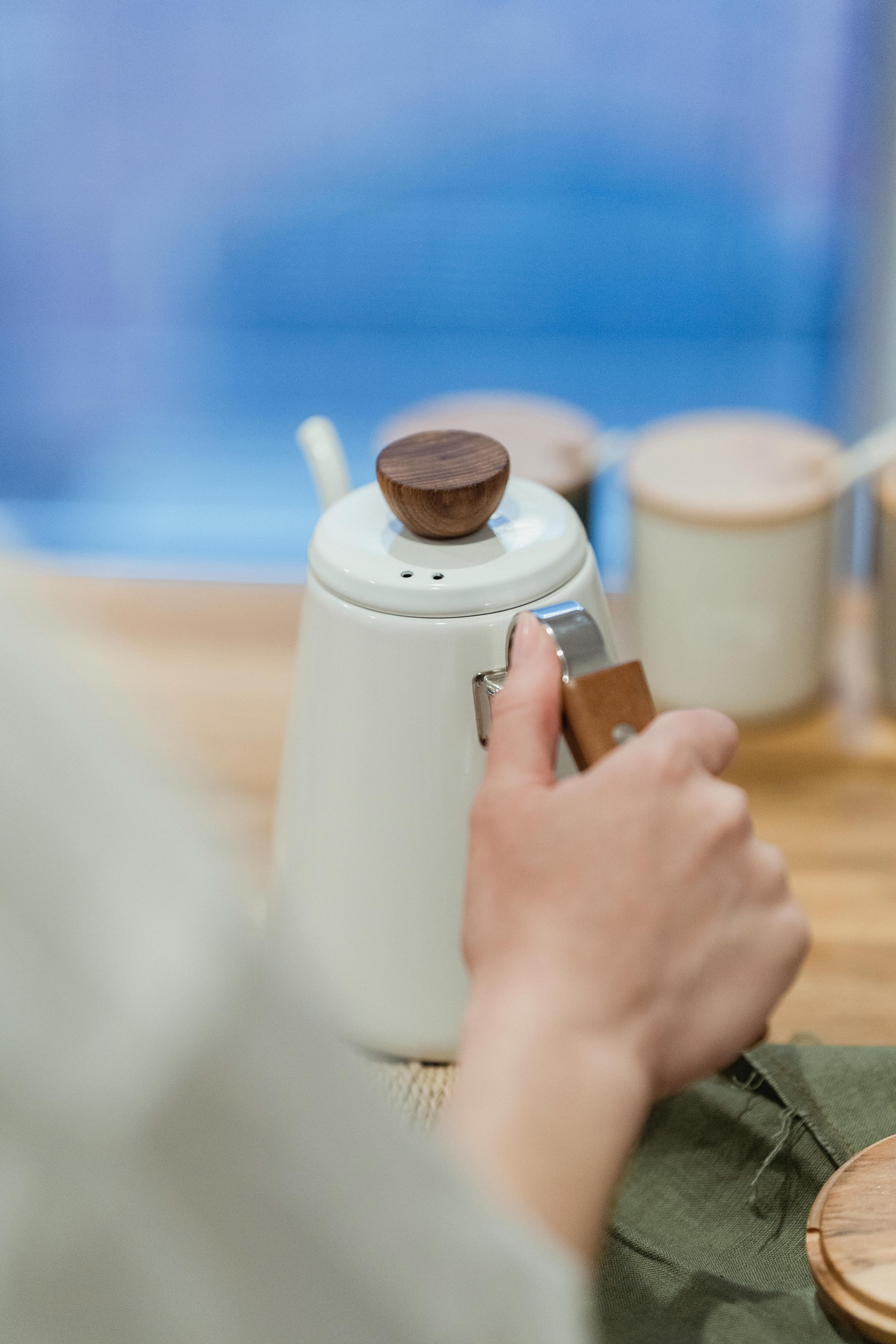 A Person Holding a Teapot · Free Stock Photo