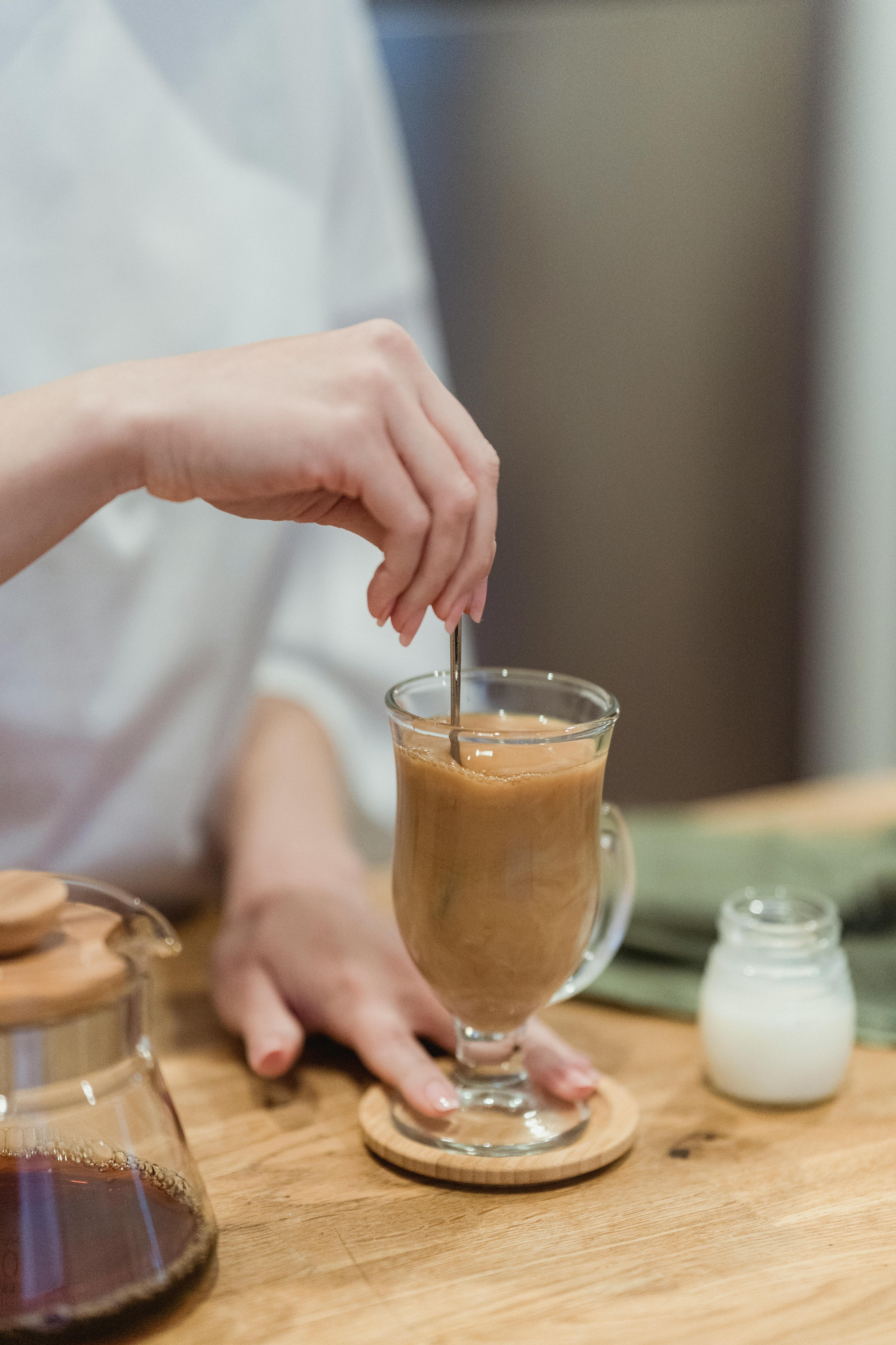 Hand Pouring Coffee into Cup · Free Stock Photo