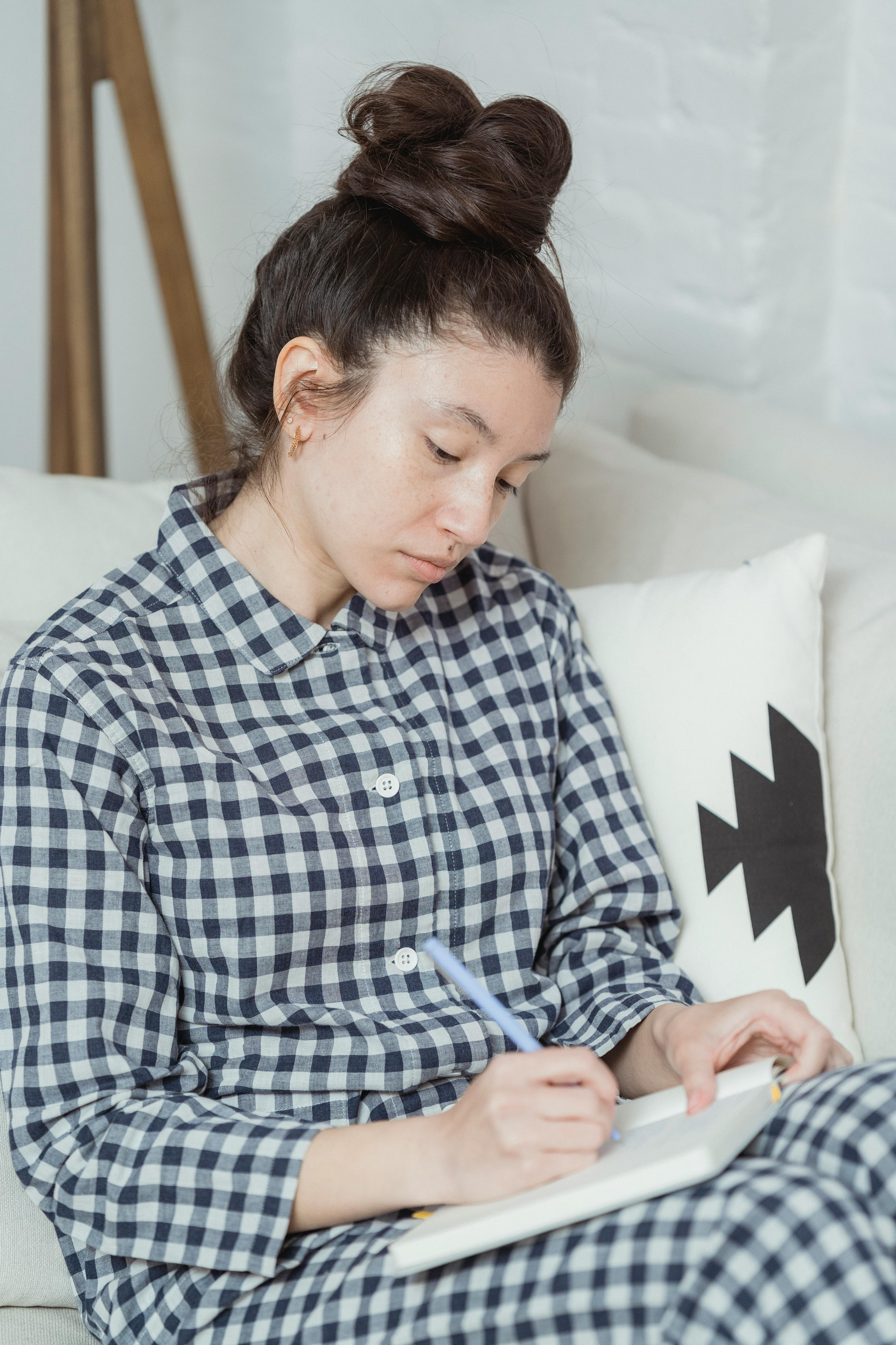 Sitting Woman Writing in Notebook · Free Stock Photo