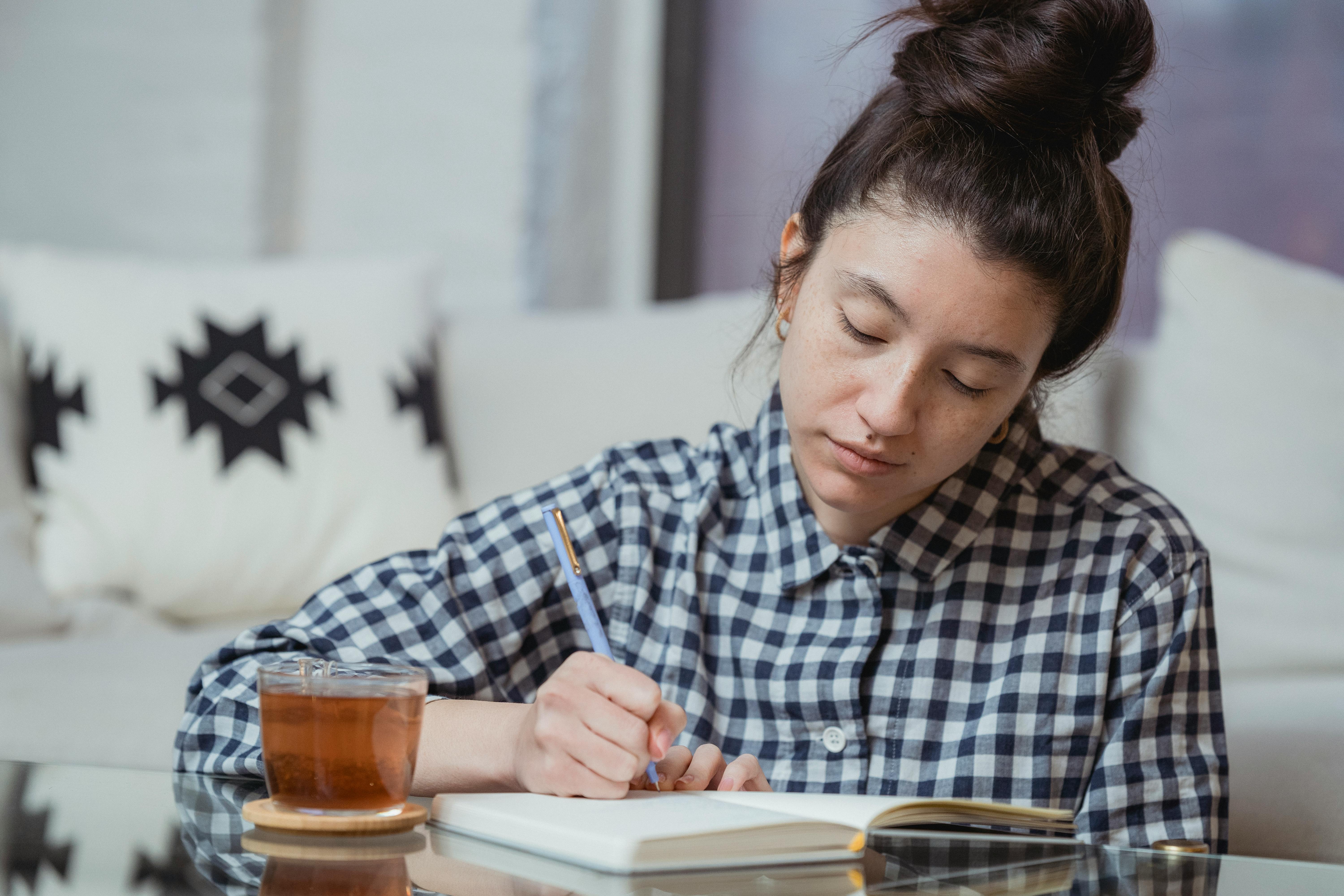 Woman Taking Notes in Notebook · Free Stock Photo