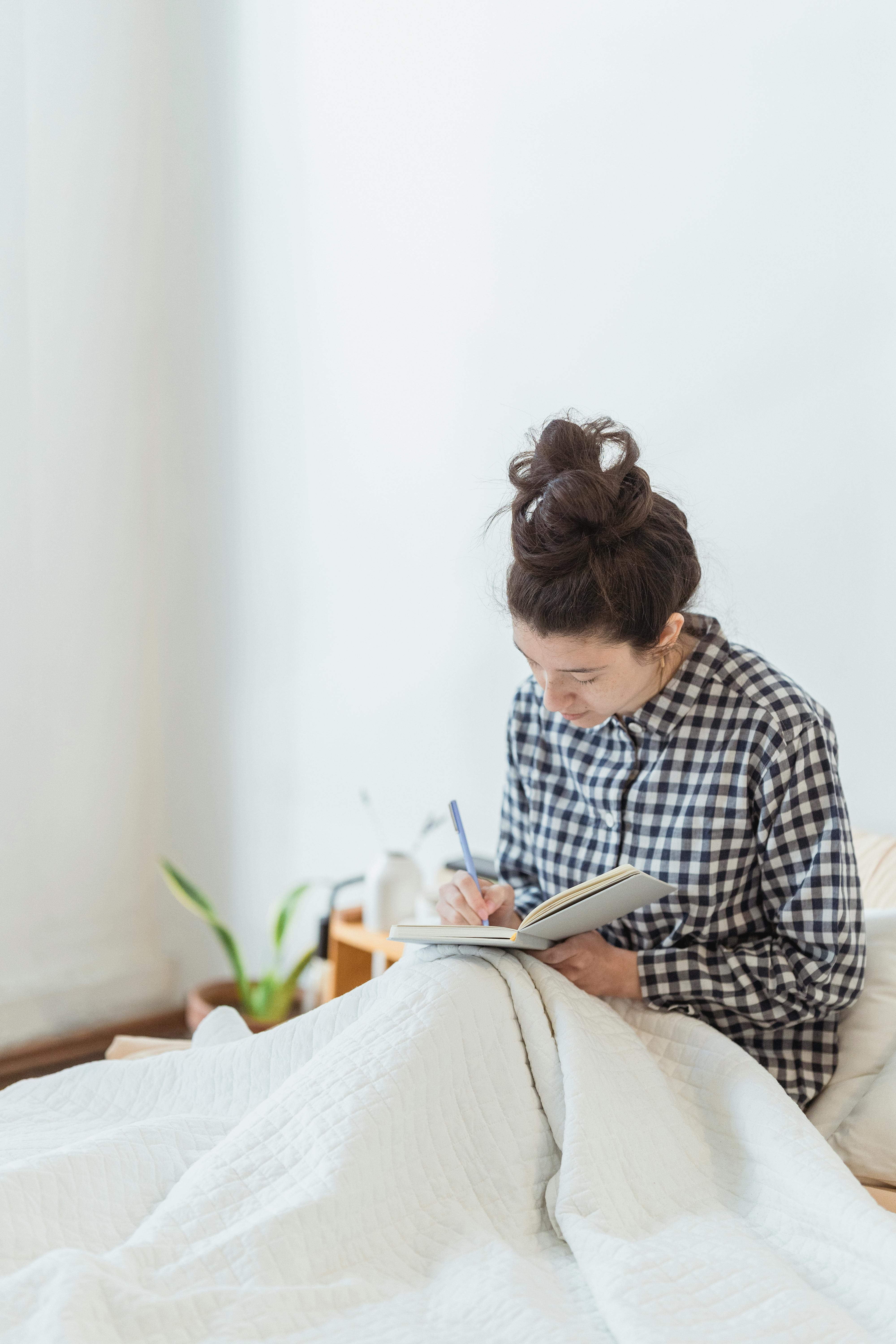 Woman Writing on Bed · Free Stock Photo