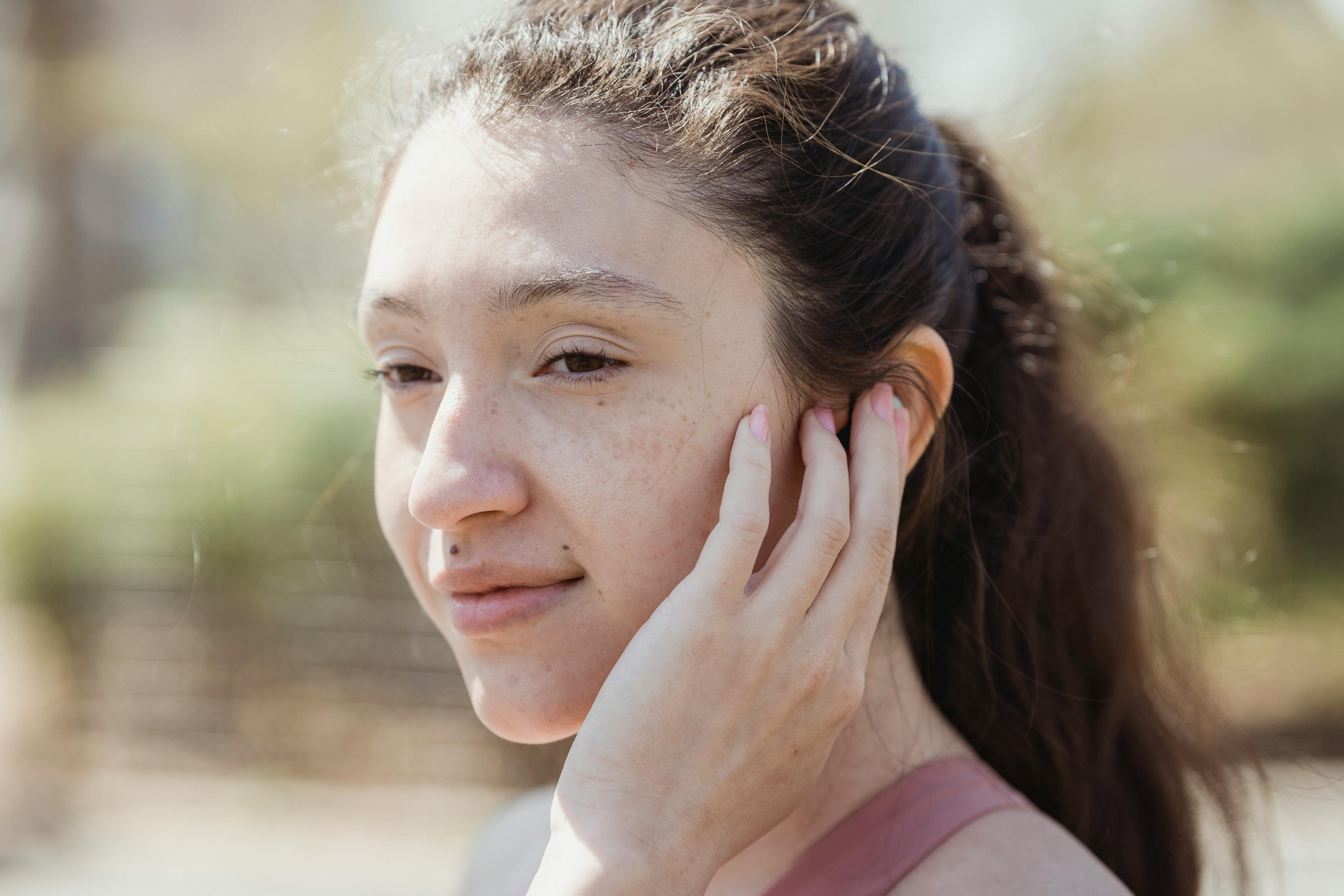 Close Up of Woman Touching Face · Free Stock Photo