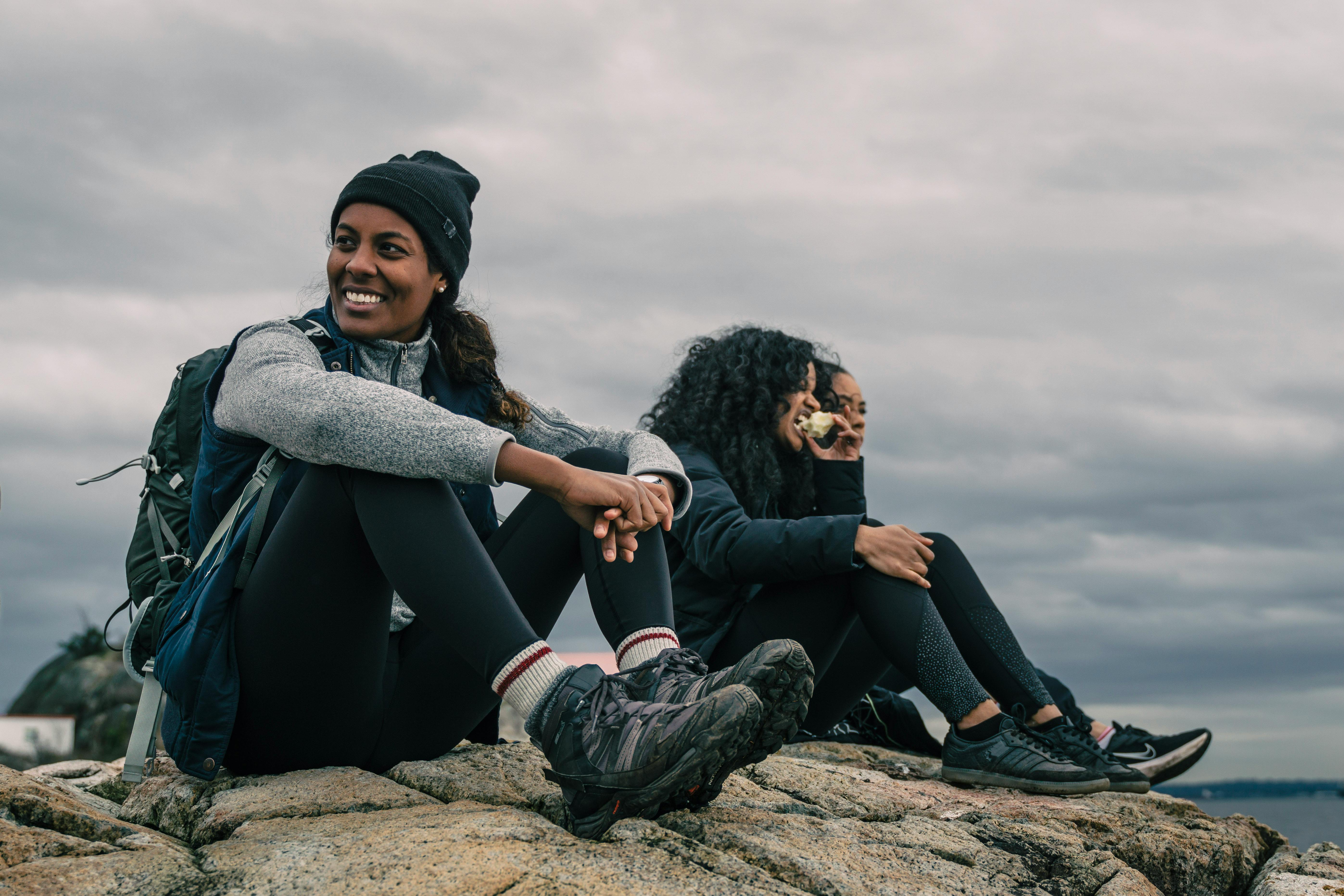 Women Sitting on a Cliff · Free Stock Photo