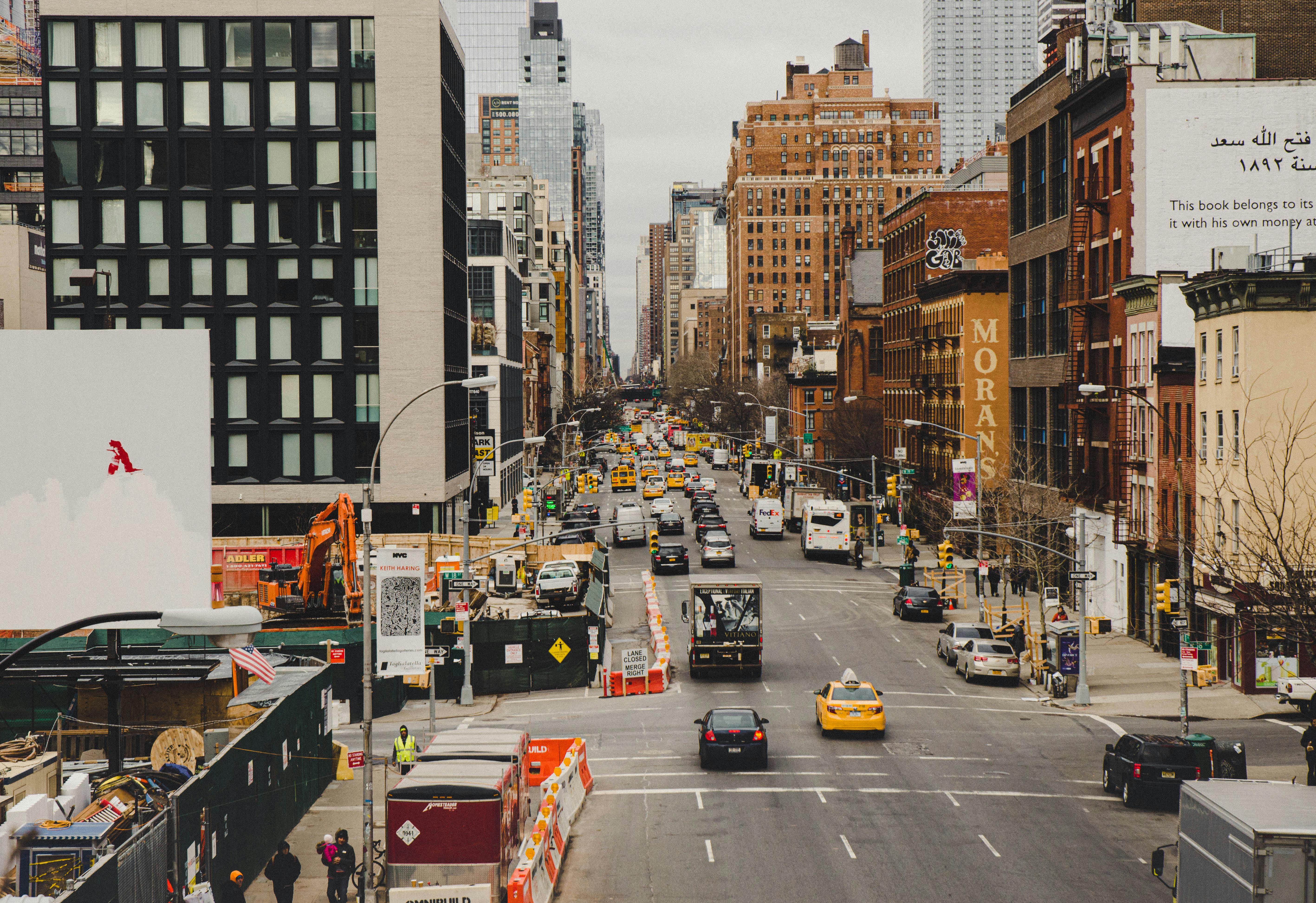 Vehicles on Road Between High-rise Buildings · Free Stock Photo