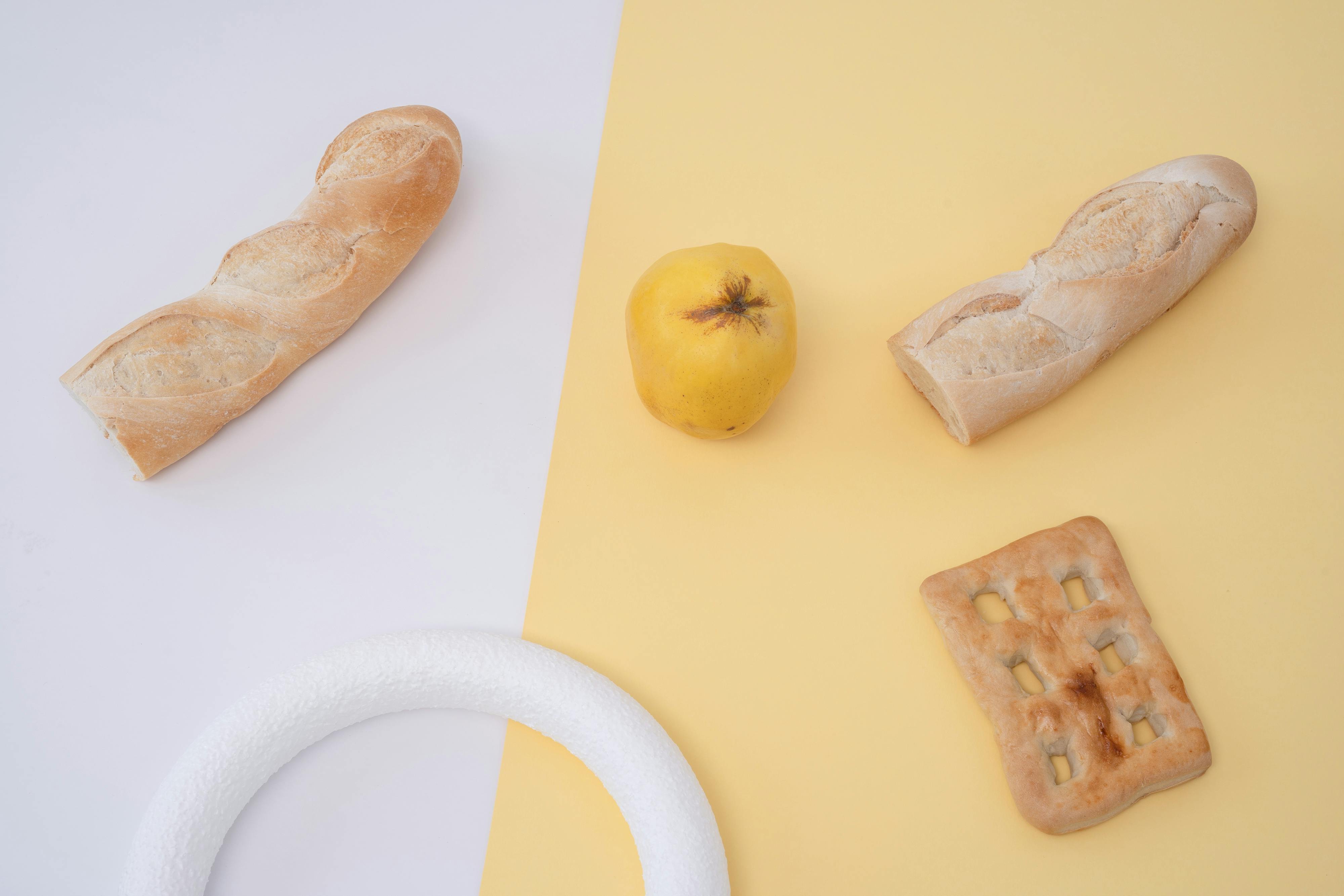 A Yellow Quince Besides Breads · Free Stock Photo