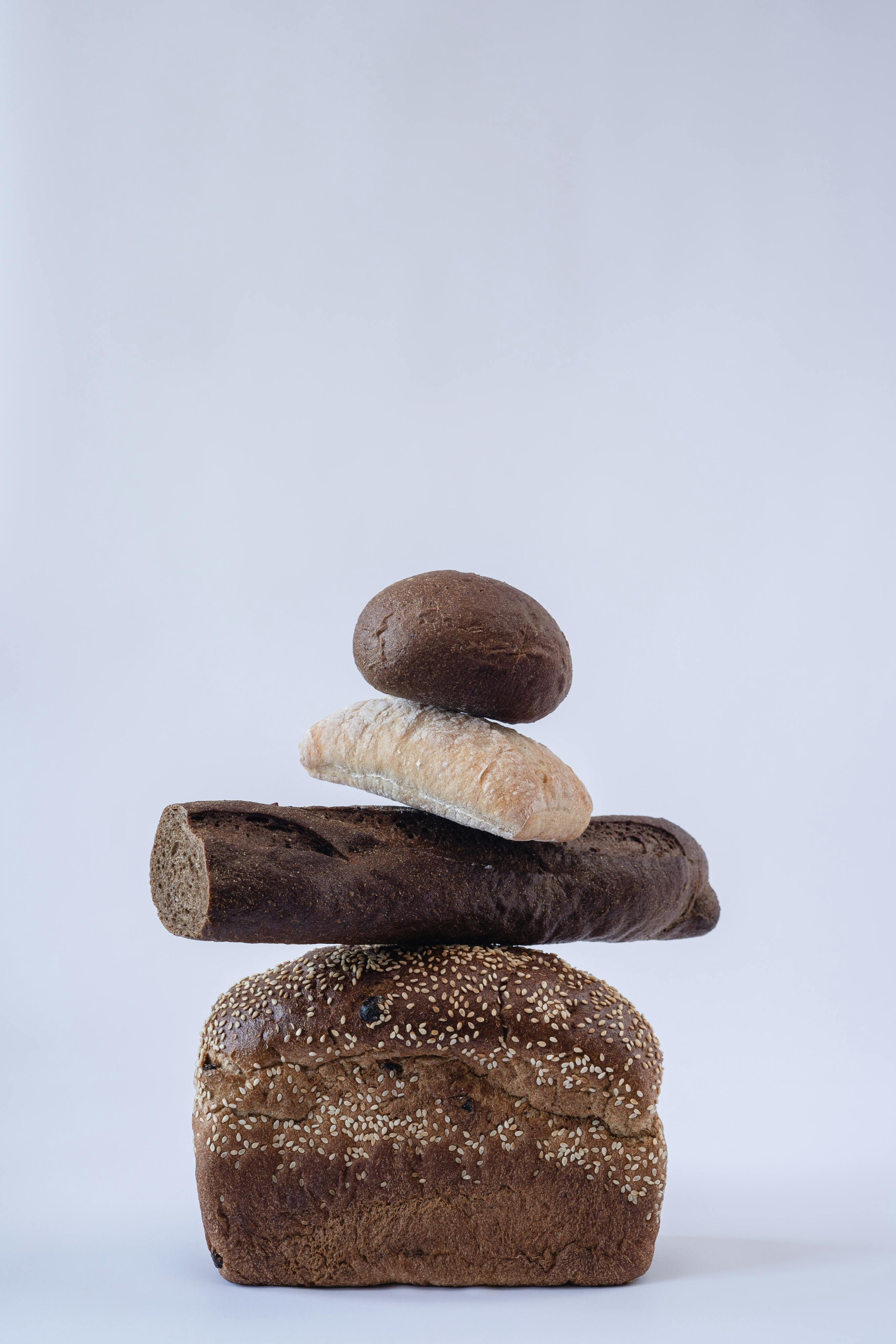 Stacks of Brown Breads on a White Surface · Free Stock Photo