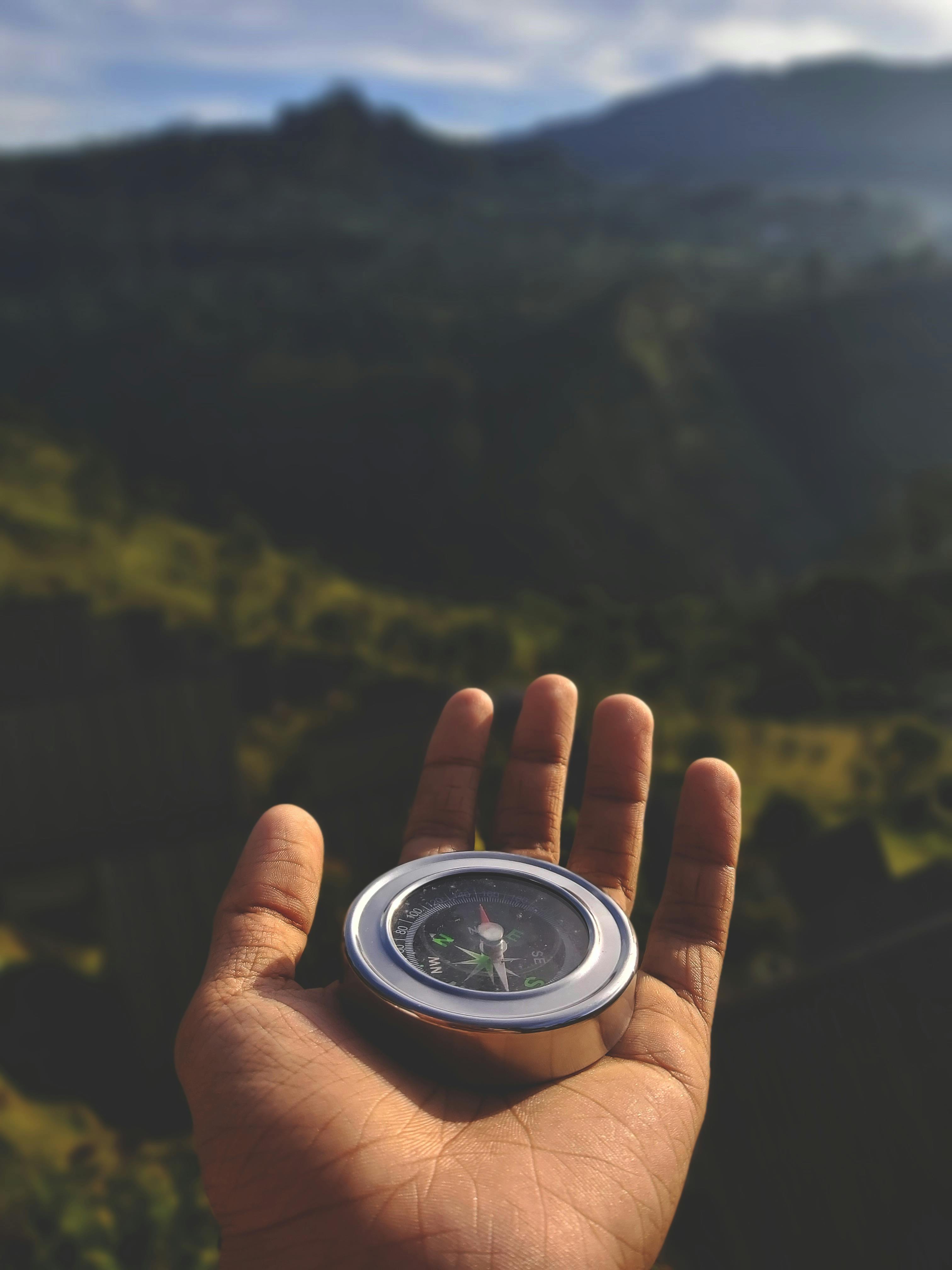 Close-Up Shot of a Person Holding a Compass · Free Stock Photo