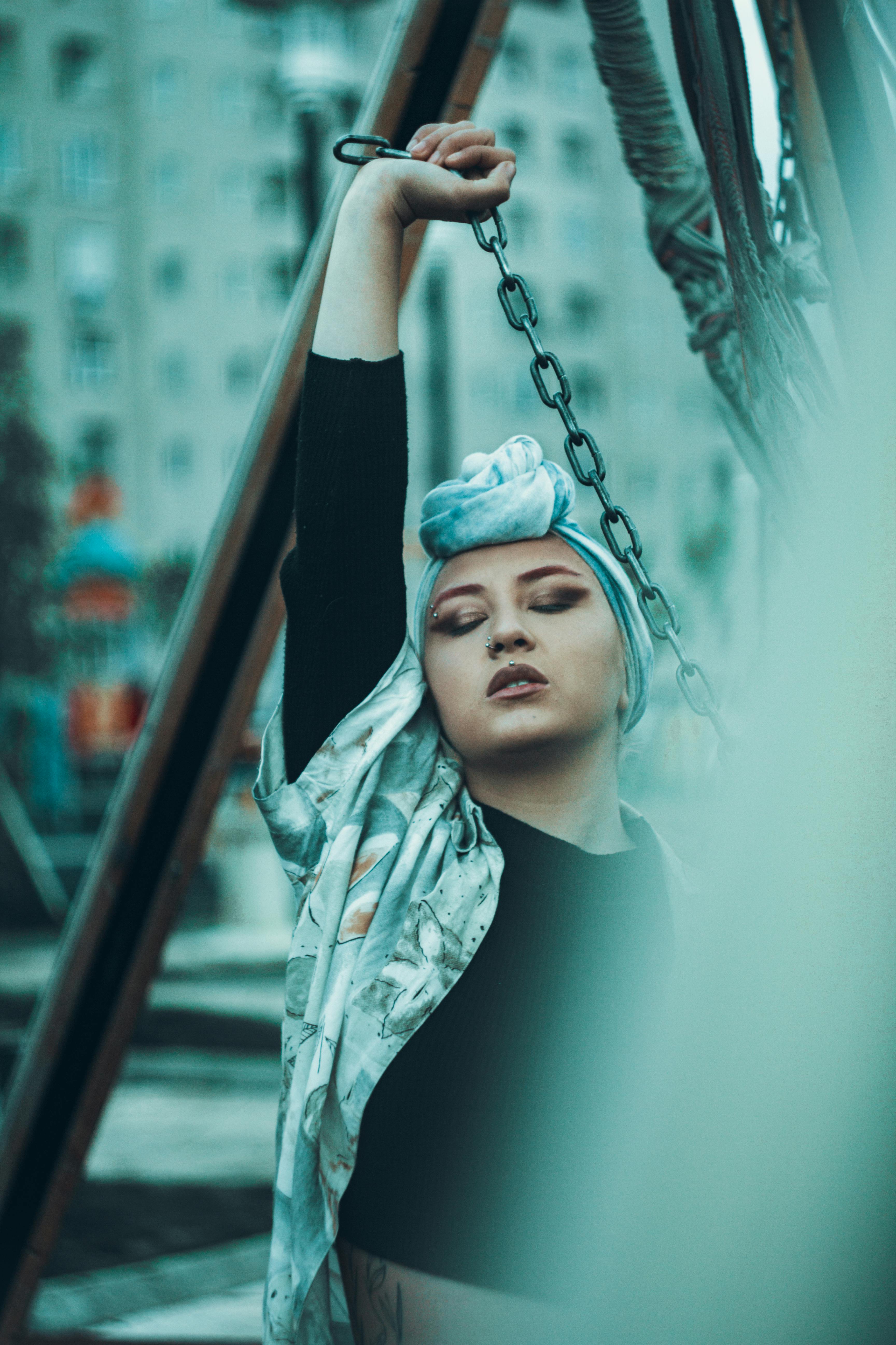Woman Wearing Headscarf Holding a Chain · Free Stock Photo