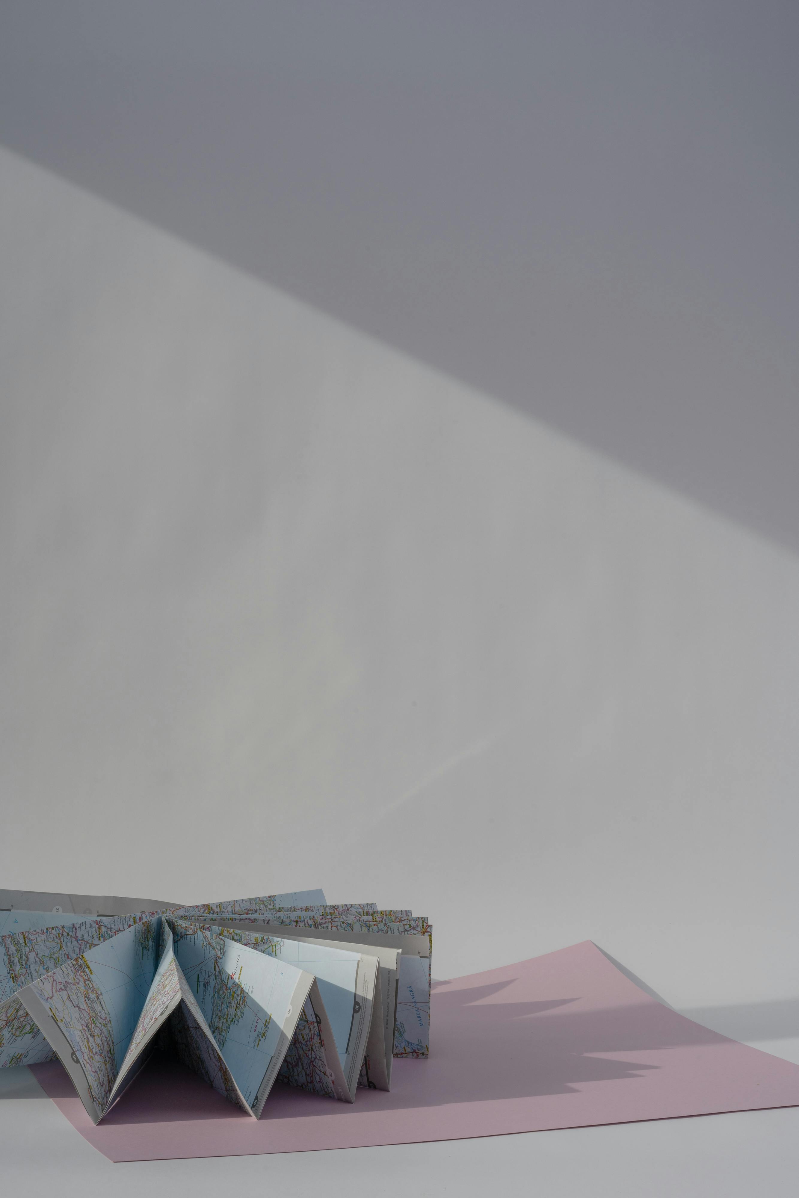 Folded Paper Map on the White Background · Free Stock Photo