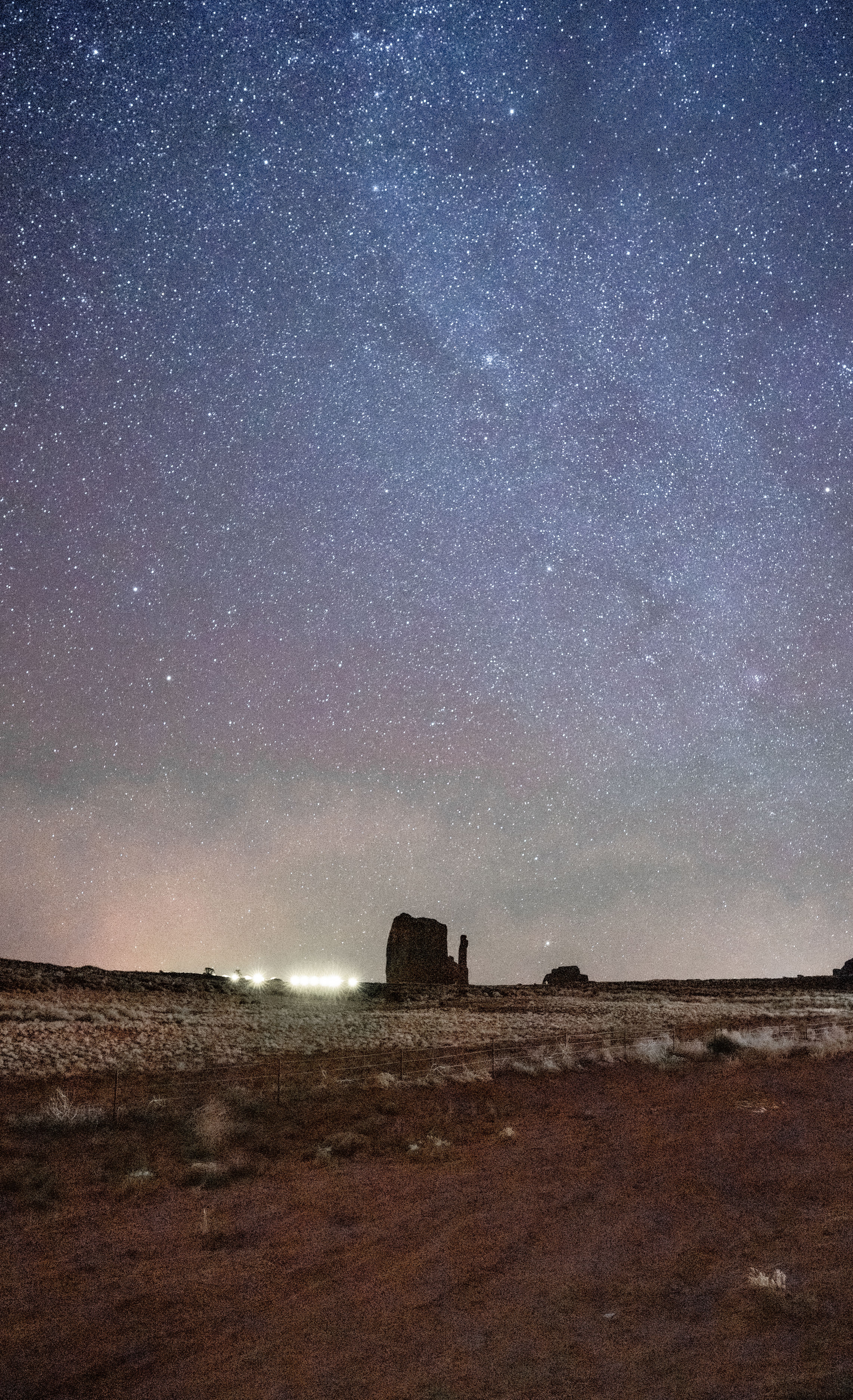 Starry sky over field with rocky formations · Free Stock Photo